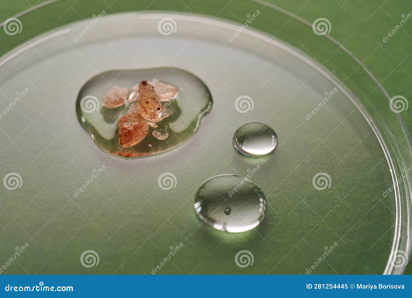 Three Drops of Liquid with Pink Salt on a Green Background. Stock Image ...