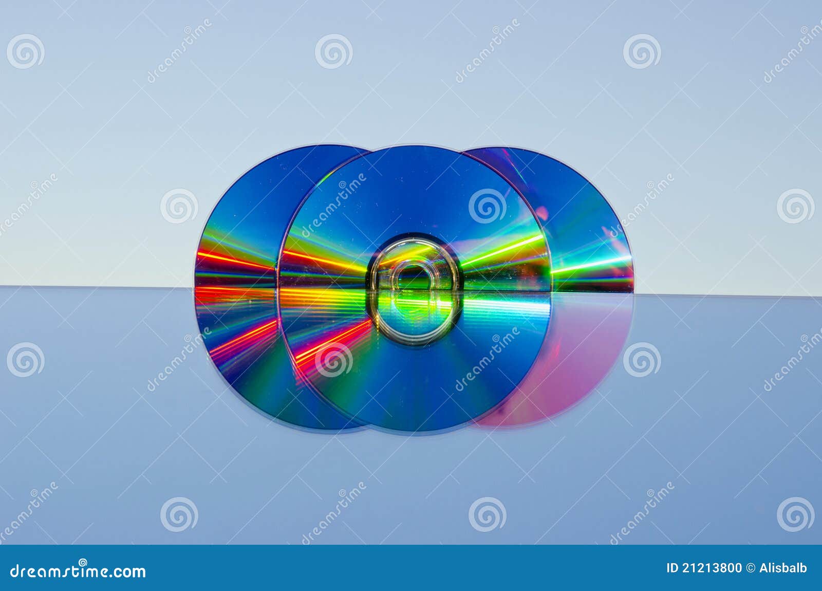 Three dvd discs on mirror stock photo. Image of information - 21213800