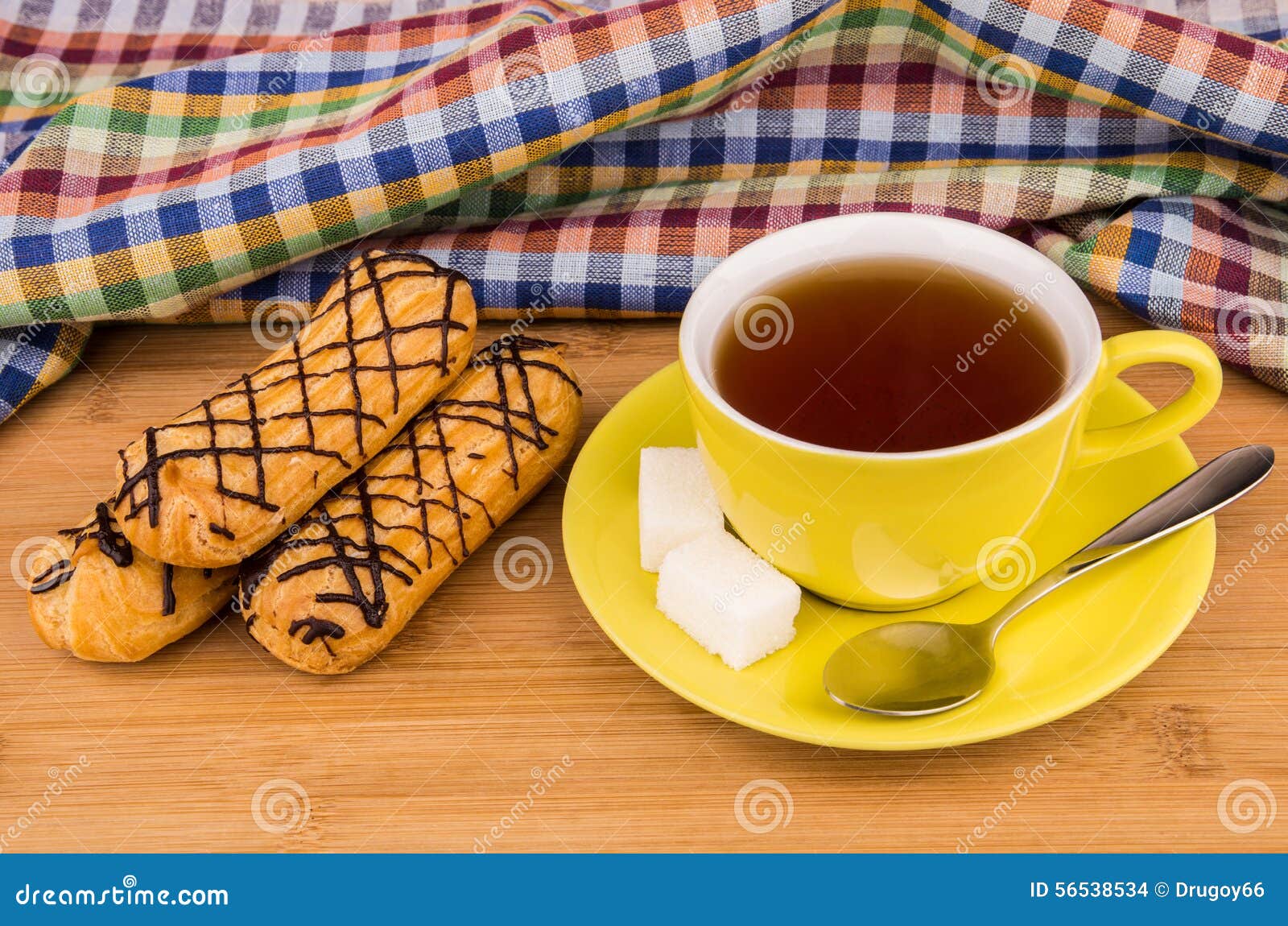 Three Eclairs, Hot Tea in Cup and Sugar on Table Stock Photo - Image of ...