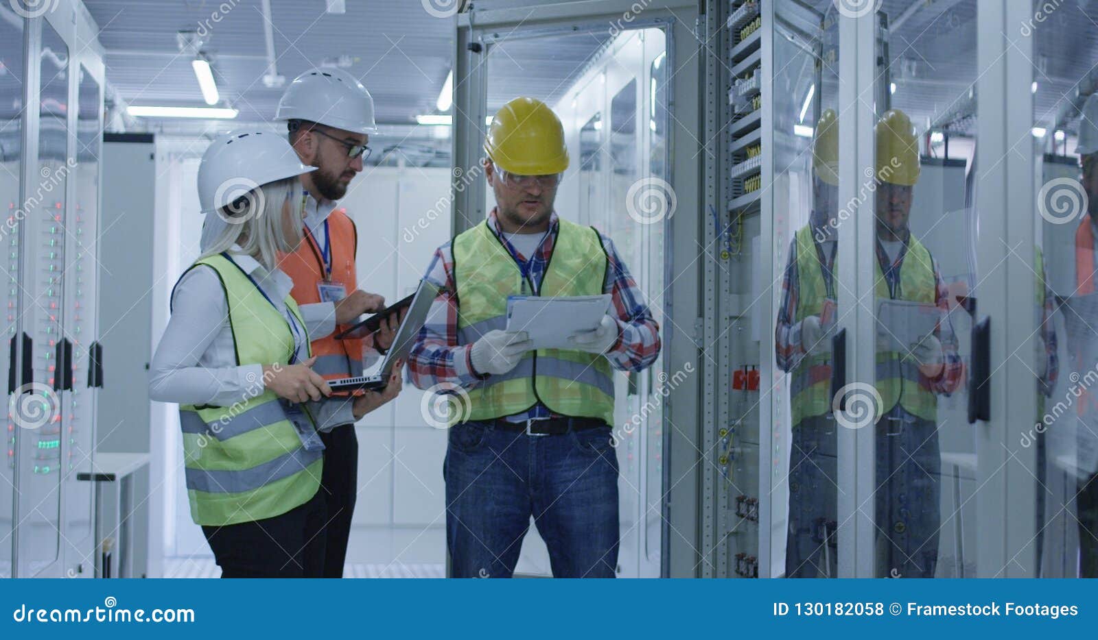 Three Electrical Workers Reviewing Documents Stock Photo - Image of ...