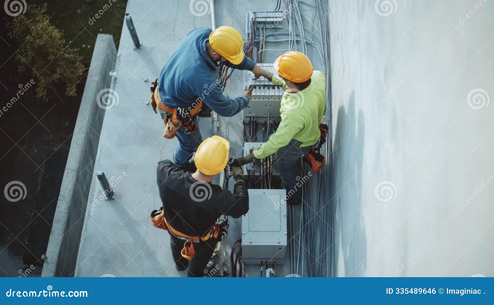 Three Electricians Working On Electrical Panel On A Roof Stock Photo ...