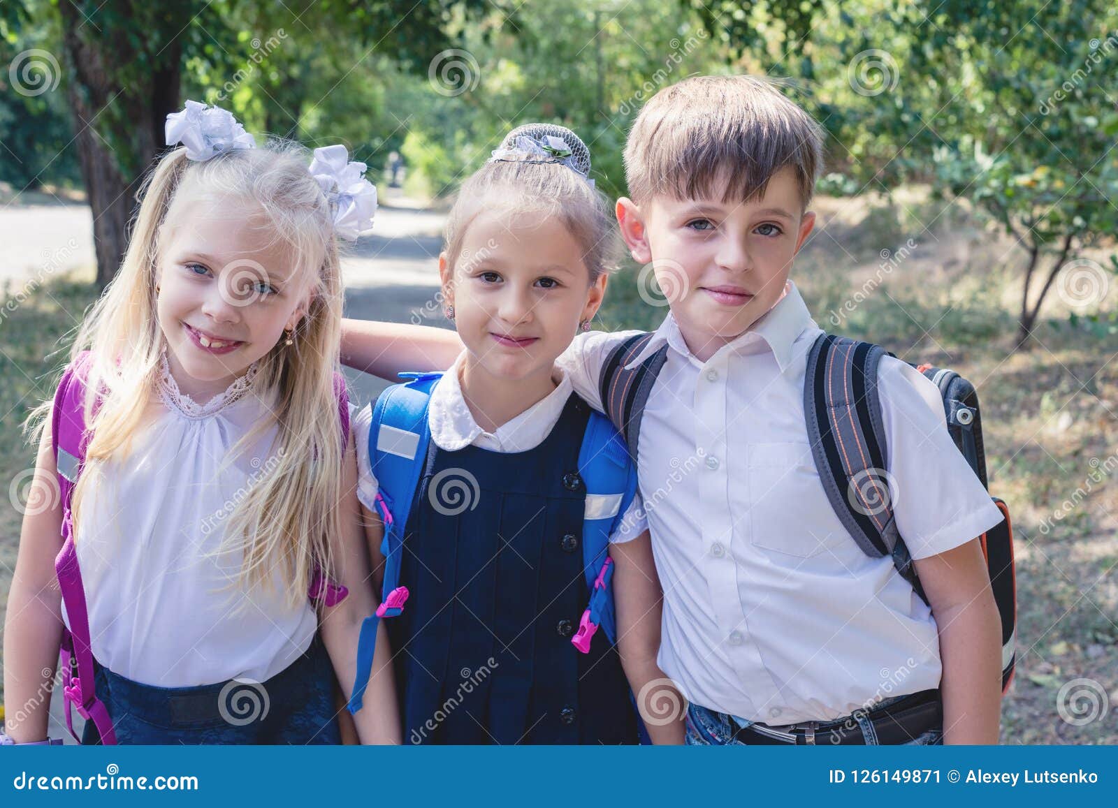Three Elementary School Students with Backpacks Stock Image - Image of ...