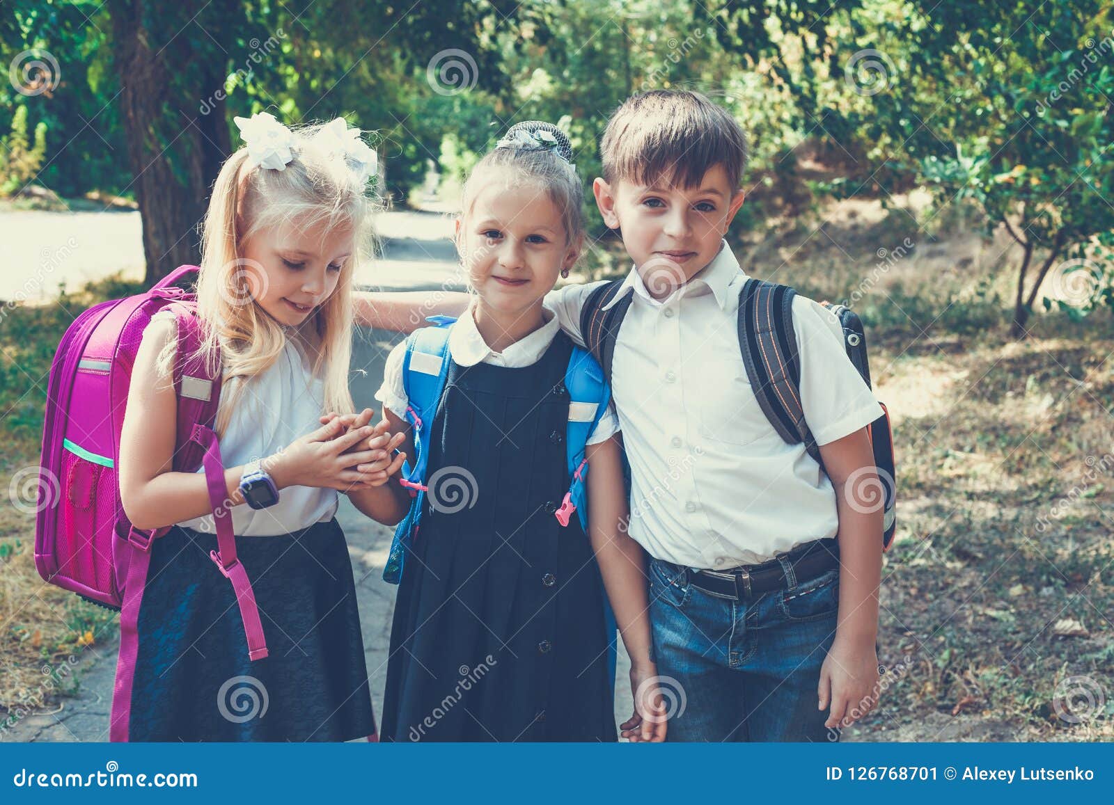 Three Elementary School Students with Backpacks Stock Image - Image of ...