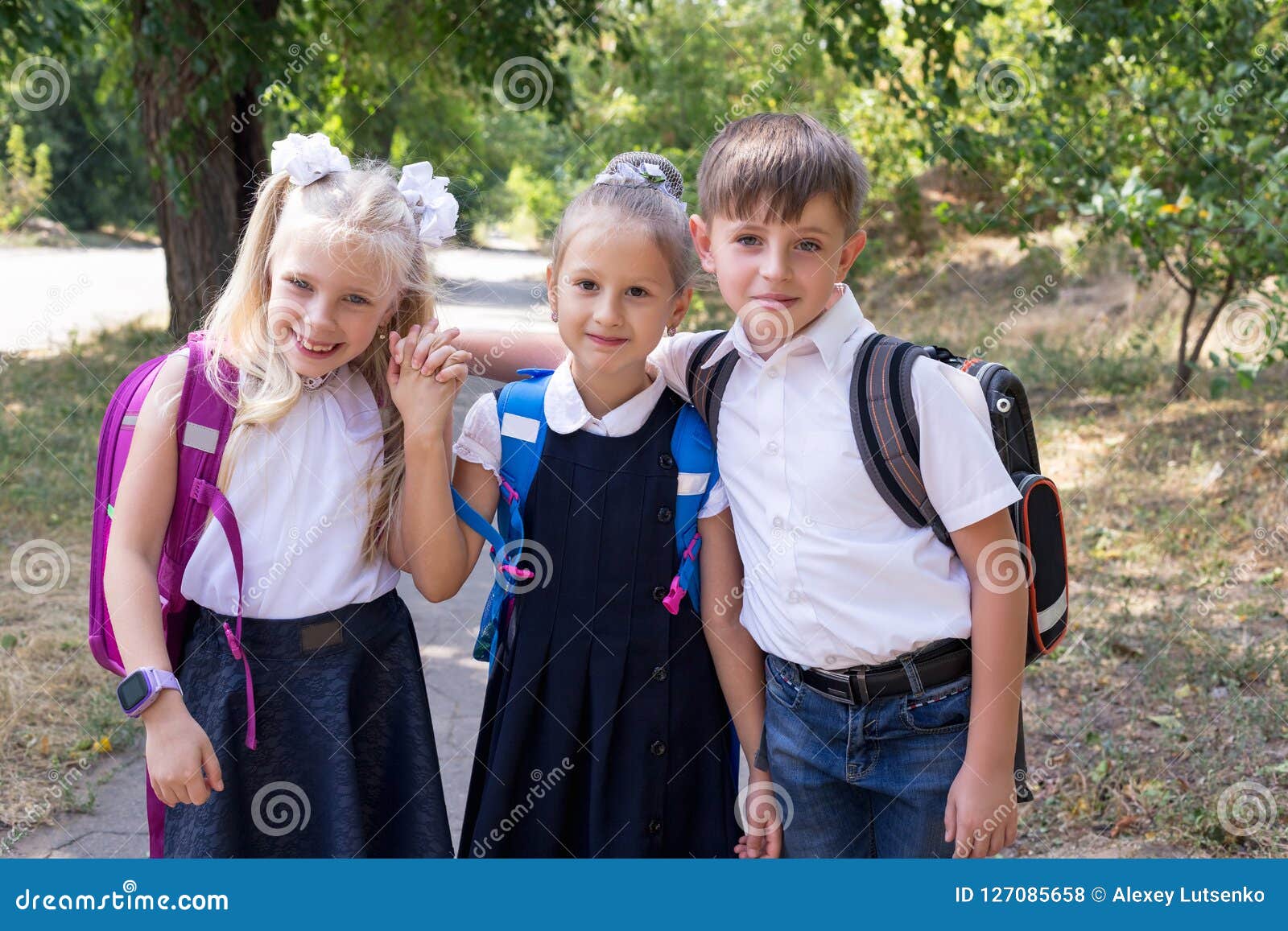 Three Elementary School Students with Backpacks Stock Photo - Image of ...