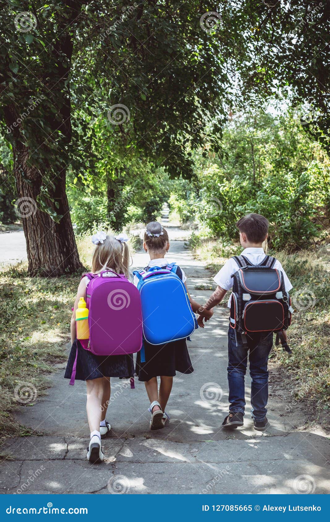 Three Elementary School Students with Backpacks Stock Image - Image of ...