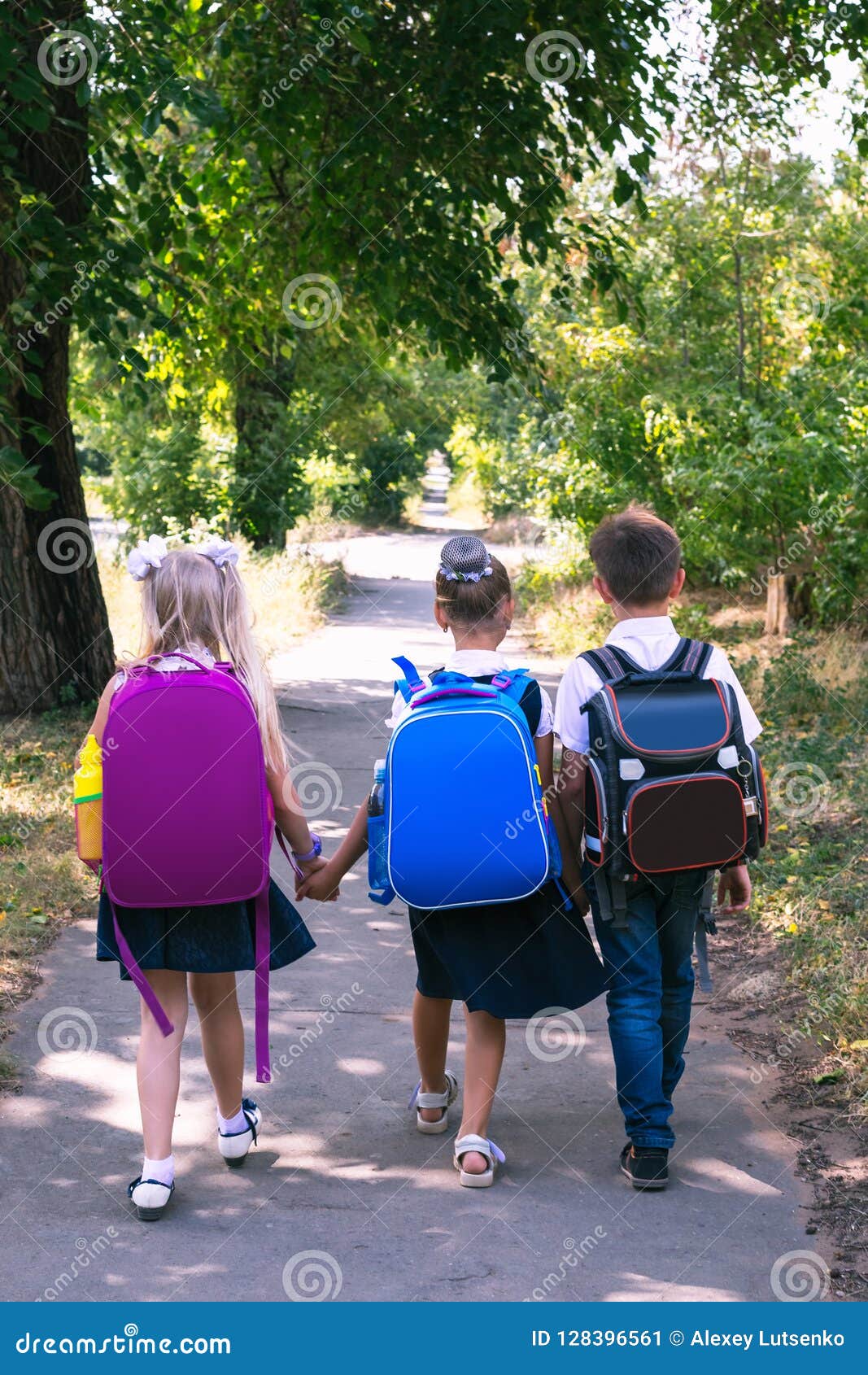 Three Elementary School Students with Backpacks Stock Image - Image of ...