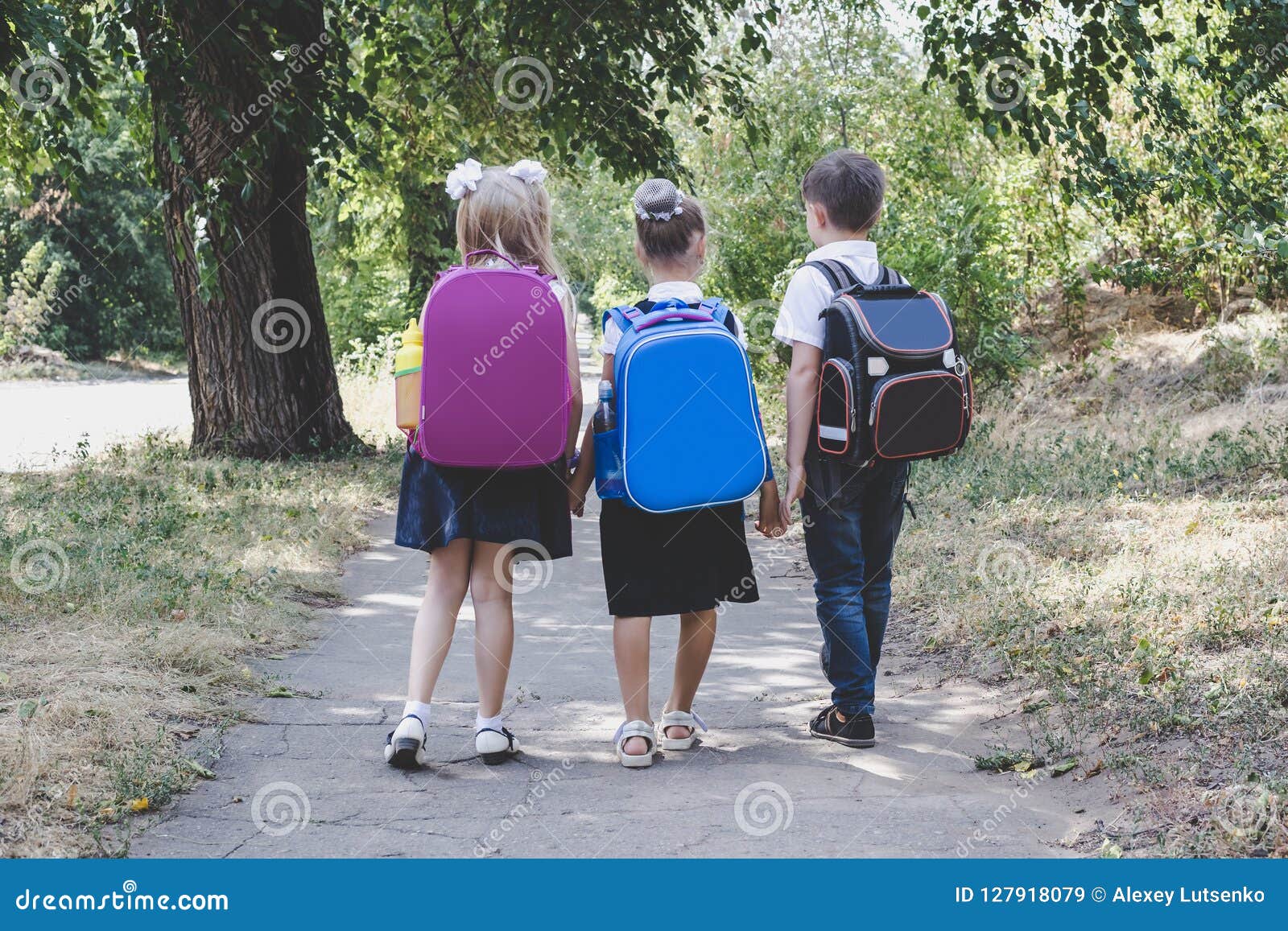 Three Elementary School Students with Backpacks Stock Image - Image of ...