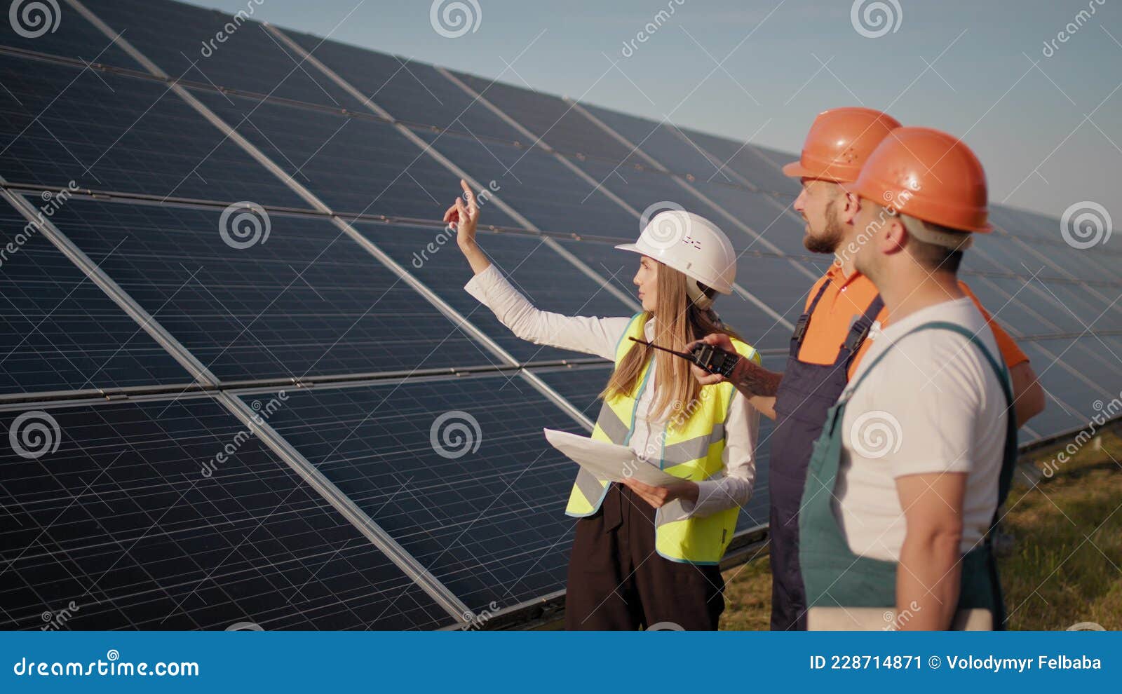 Three Employees of Alternative Power Plant Walking and Talking about ...