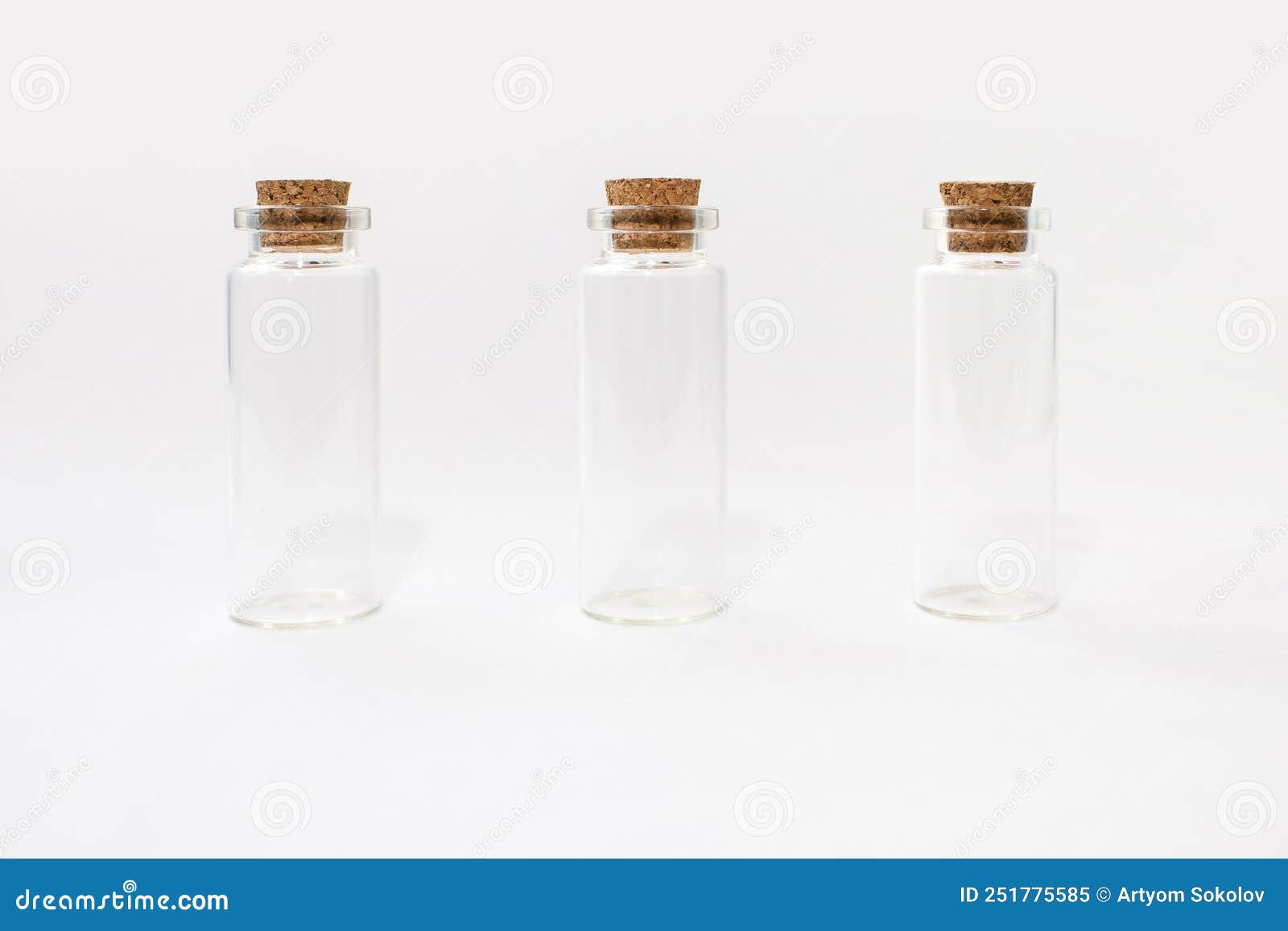 Three Empty Glass Bottles on a White Background with Corks Stock Image ...