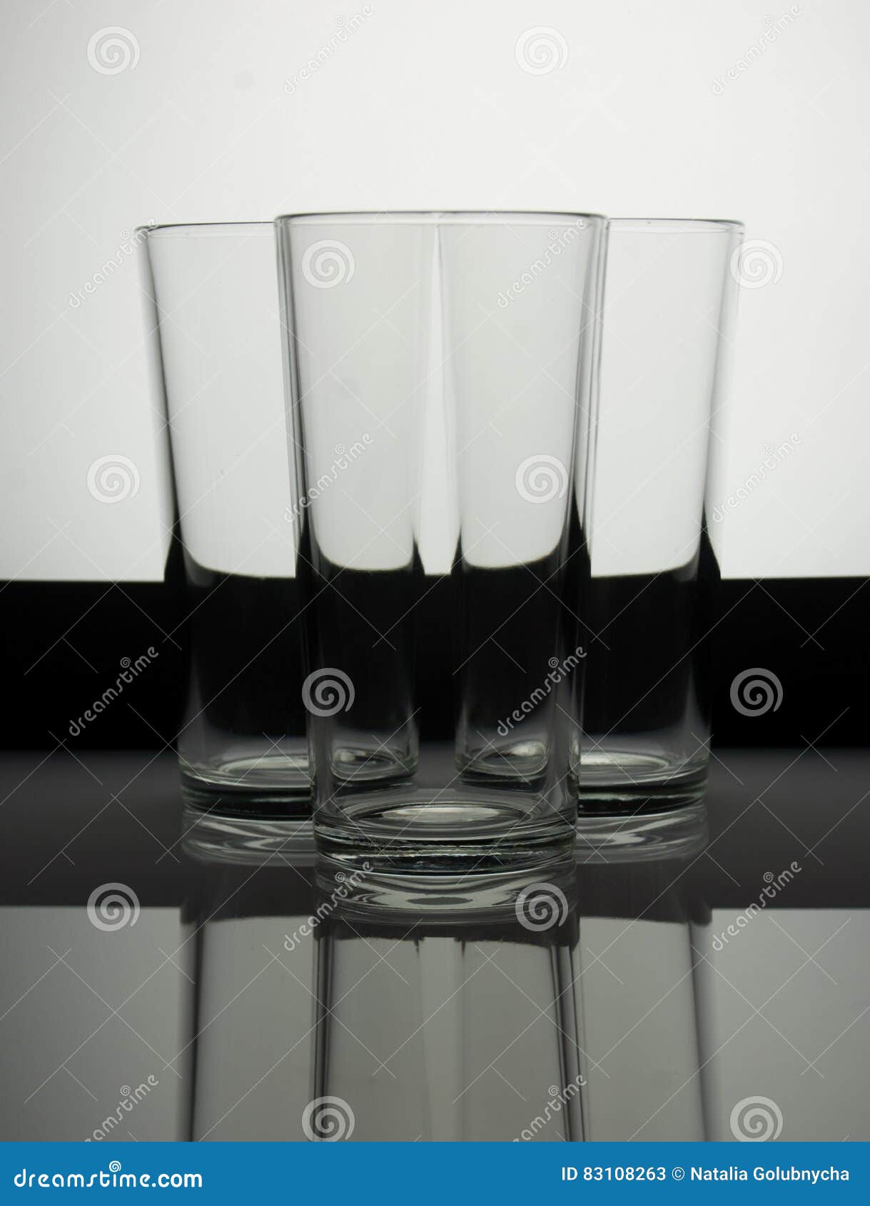 Three Empty Glasses on a Blackand White Background with Reflecti Stock ...