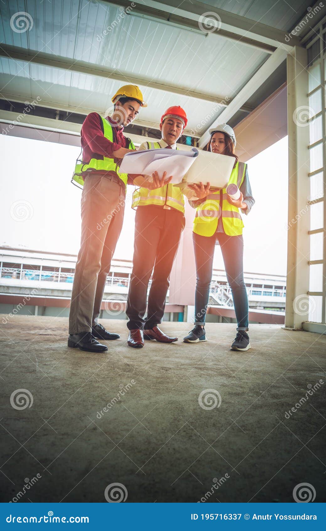 Three Engineer Male and Female Discussing on Document and Computer in a ...