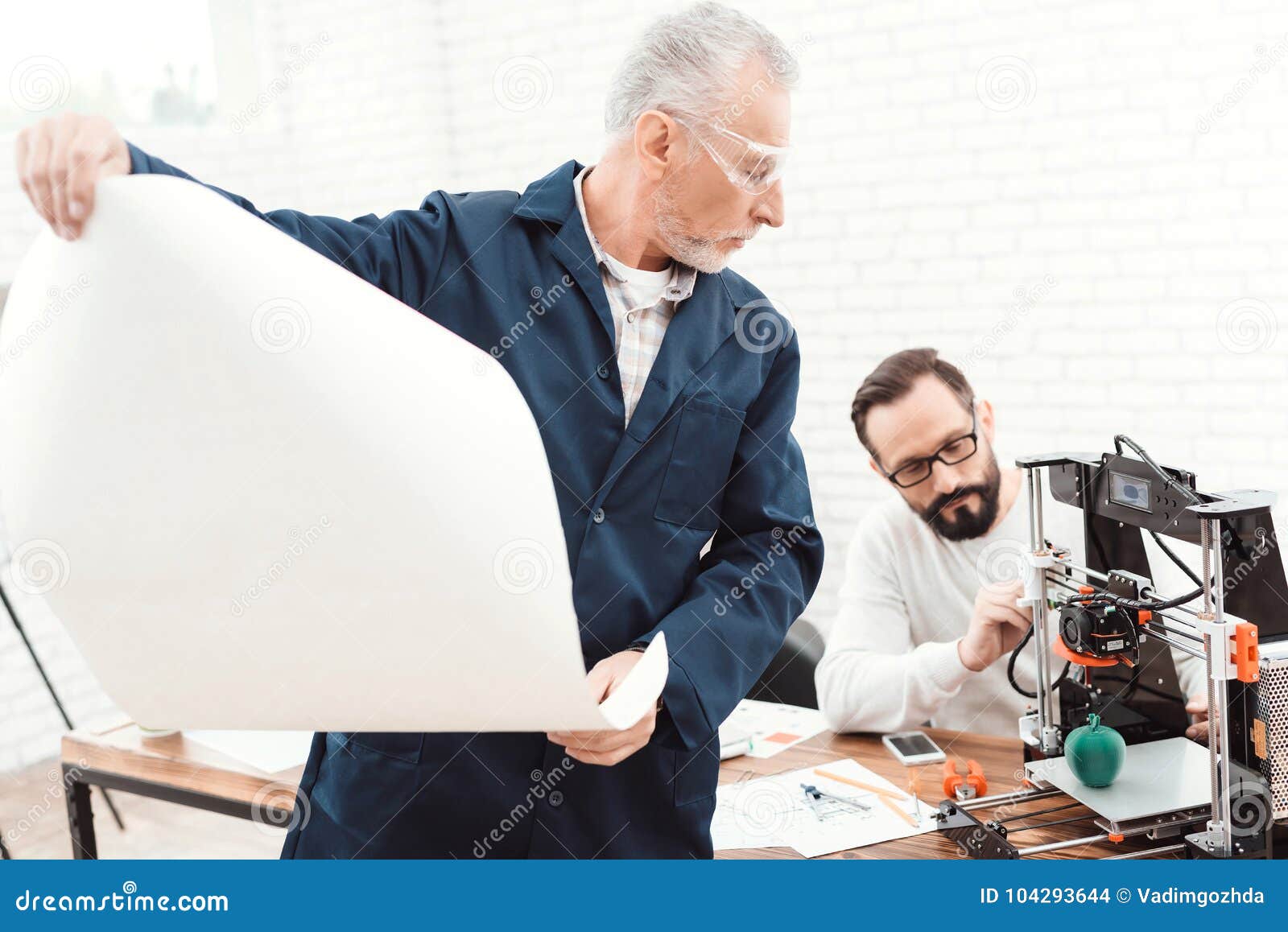 Three Engineers Work with a 3d Printer. an Elderly Man in the ...