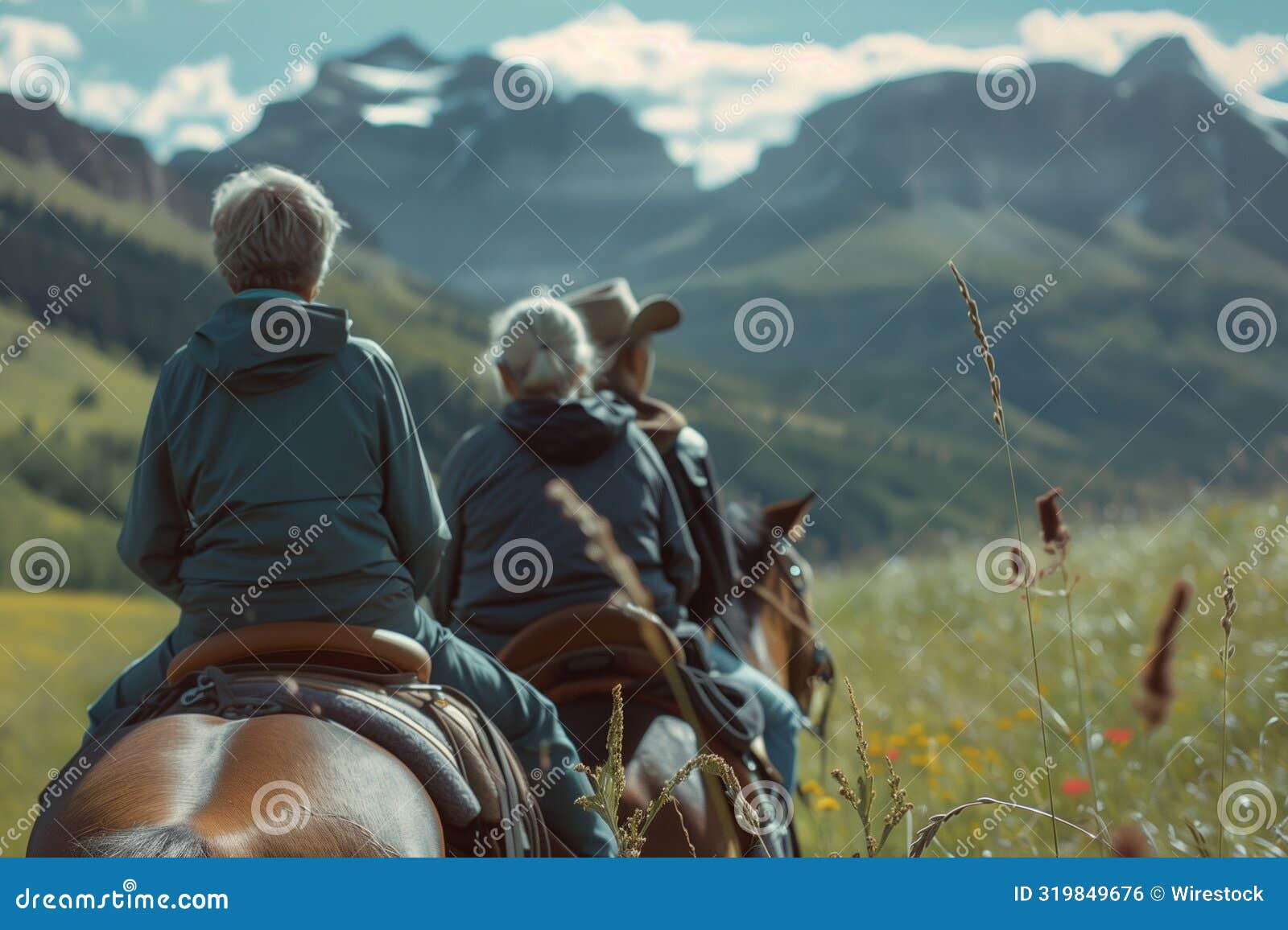 Equestrians with Mountains and Clouds in the Background Stock Photo ...