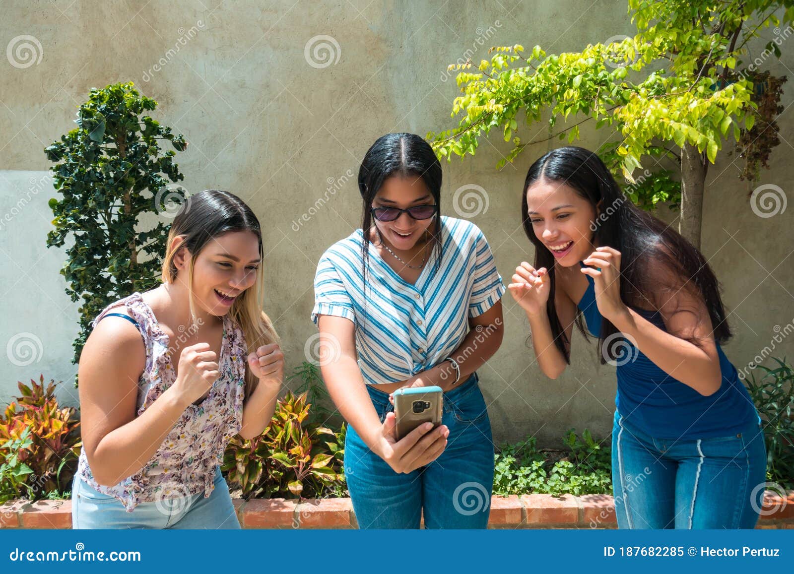 Three Excited Friends Looking at a Cell Phone Stock Image - Image of ...