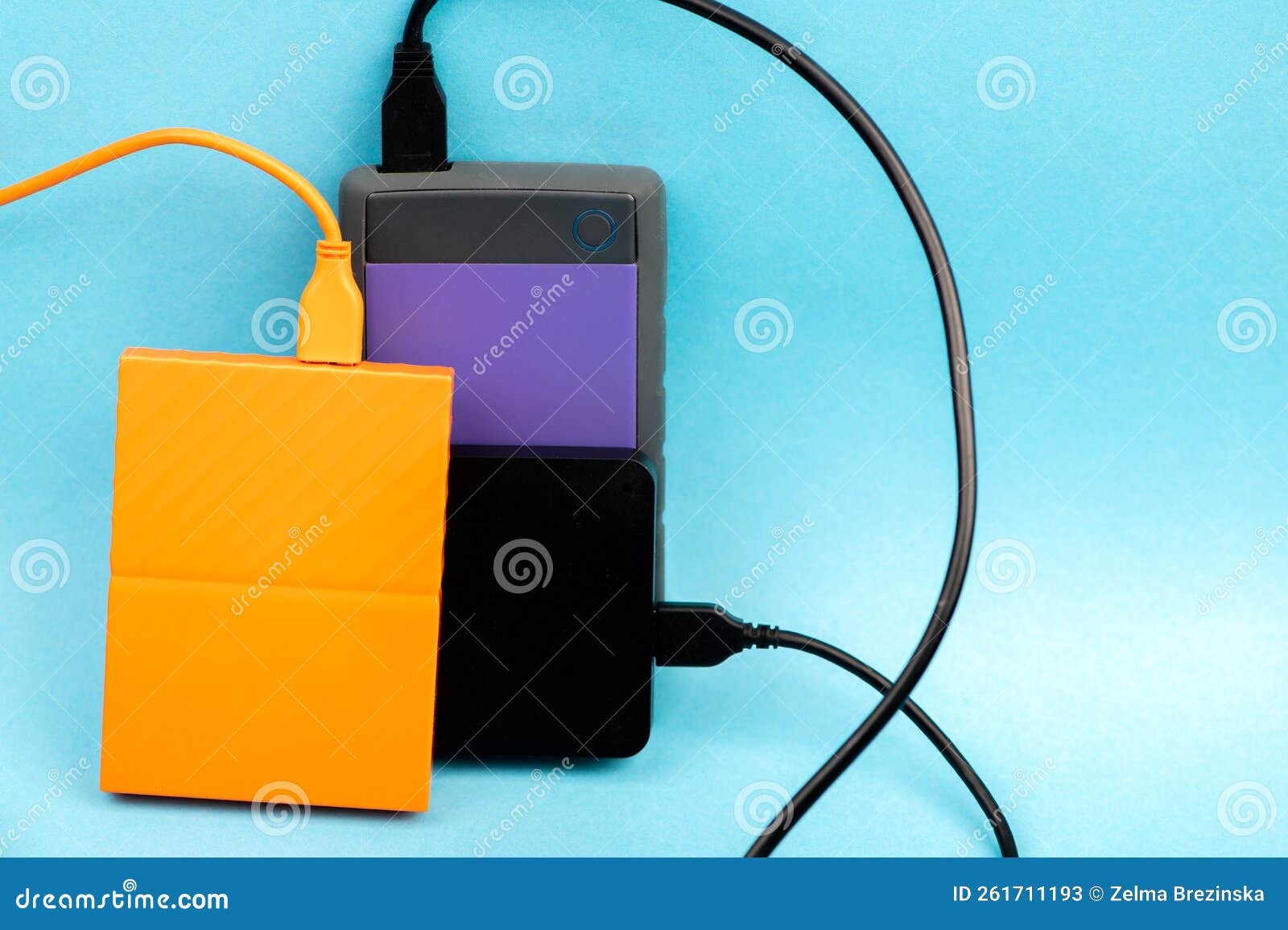 Three External Portable Hard Disk Drives Isolated on Light Blue Stock ...
