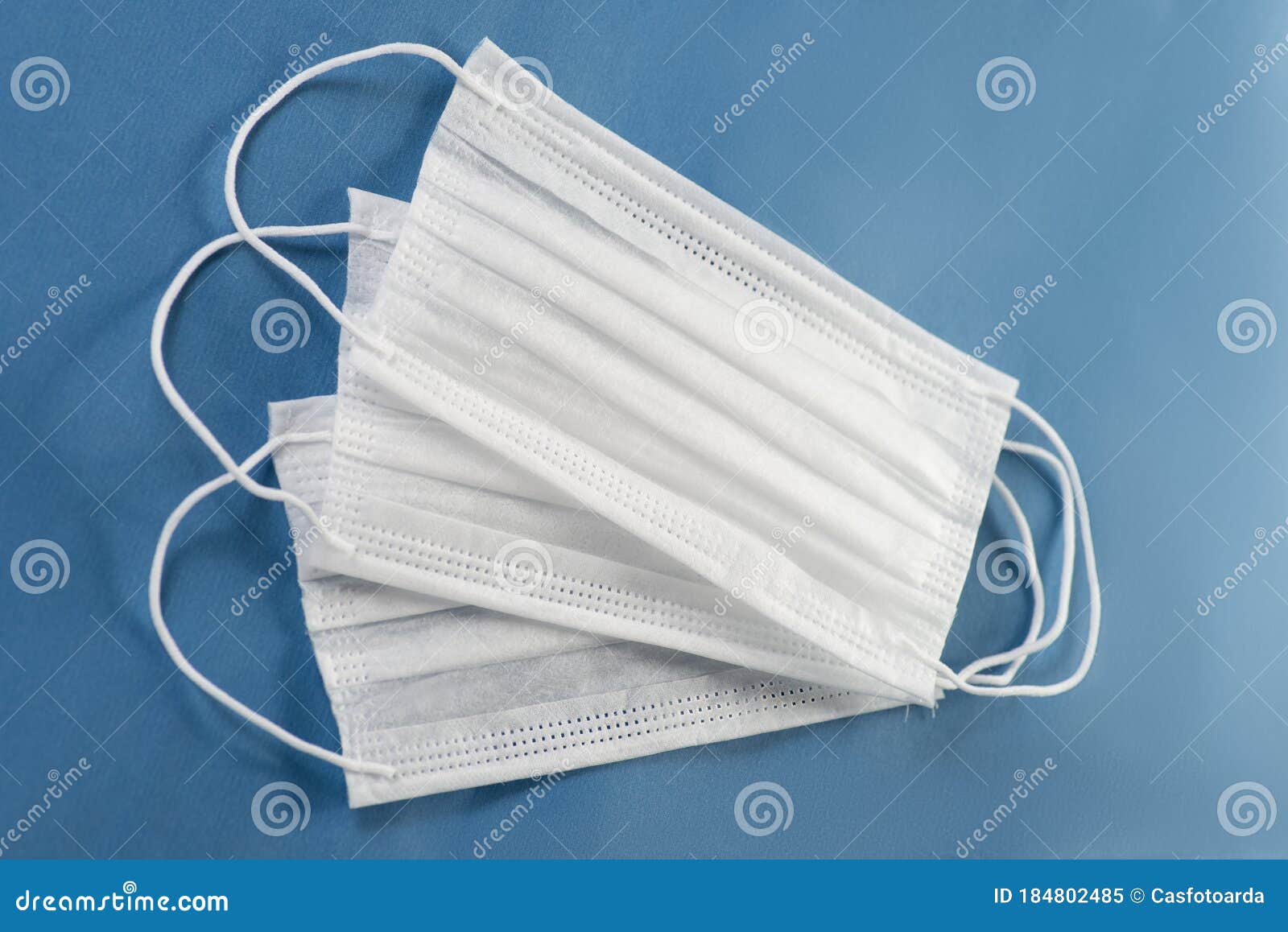Three Face Masks on a Blue Background Stock Image - Image of disposable ...