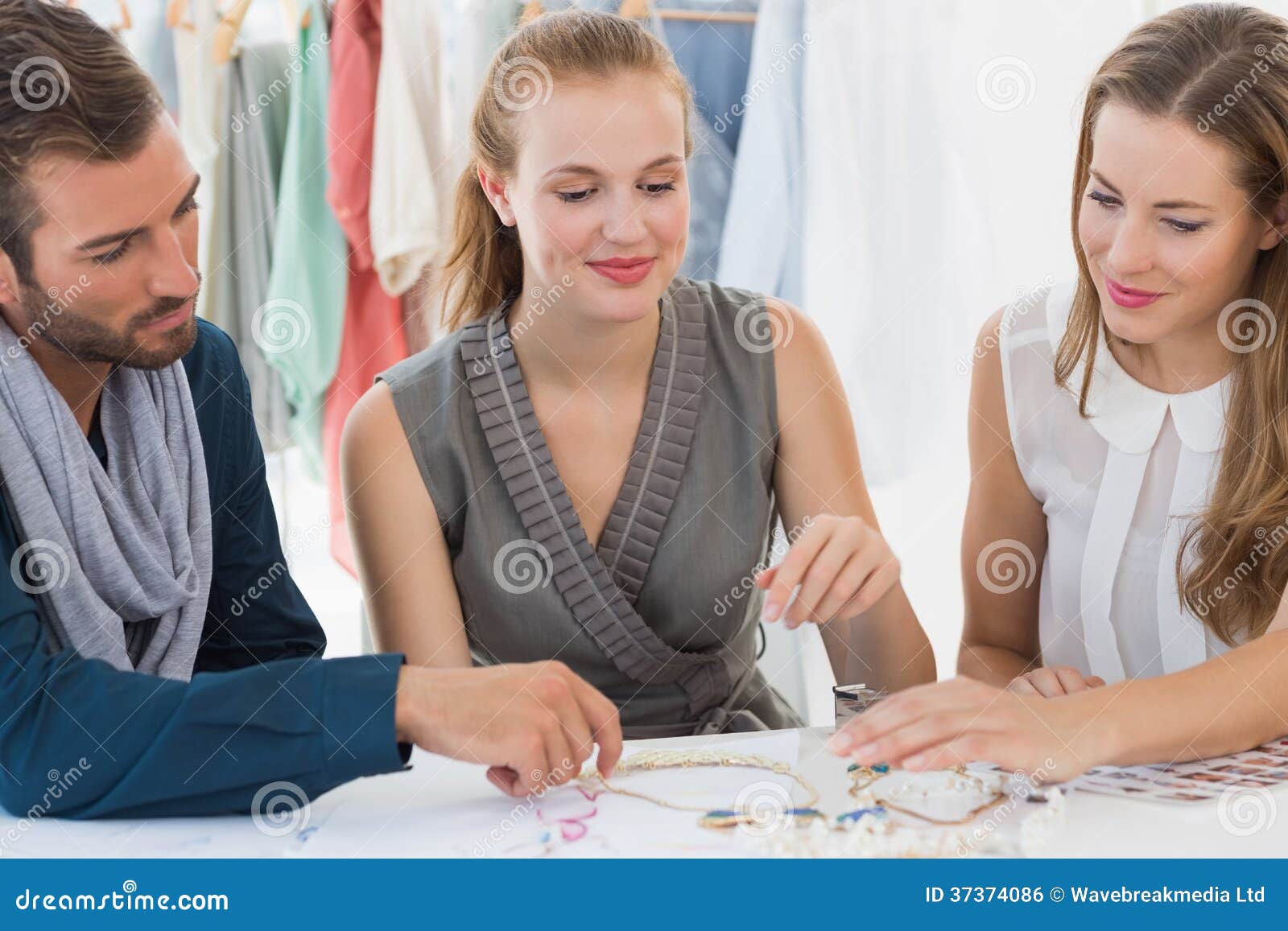 Three Fashion Designers Discussing Designs Stock Photo - Image of ...