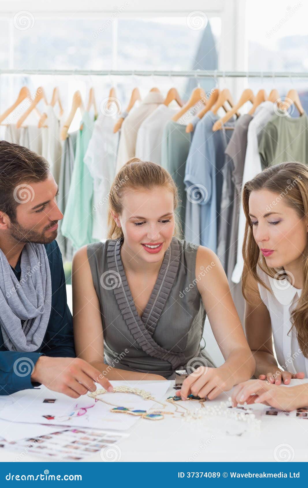 Three Fashion Designers Discussing Designs Stock Image - Image of ...