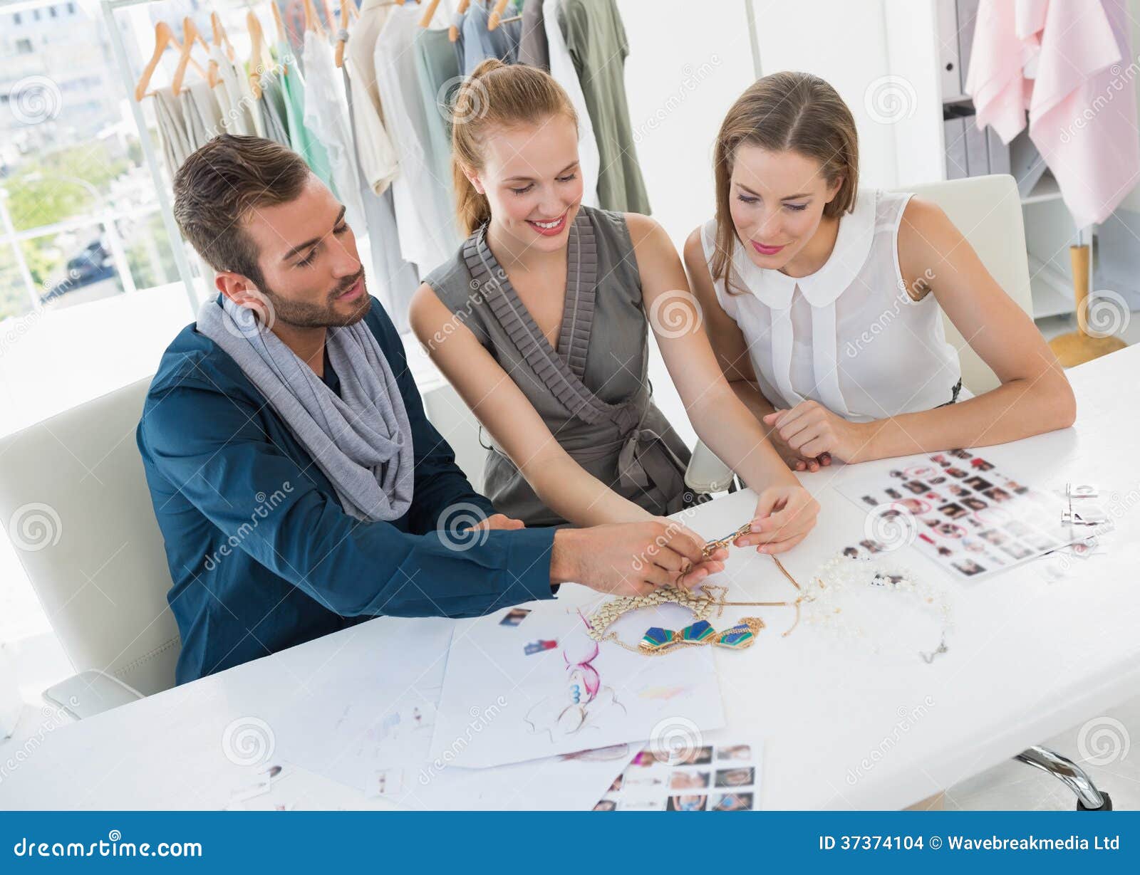 Three Fashion Designers Discussing Designs Stock Photo - Image of ...