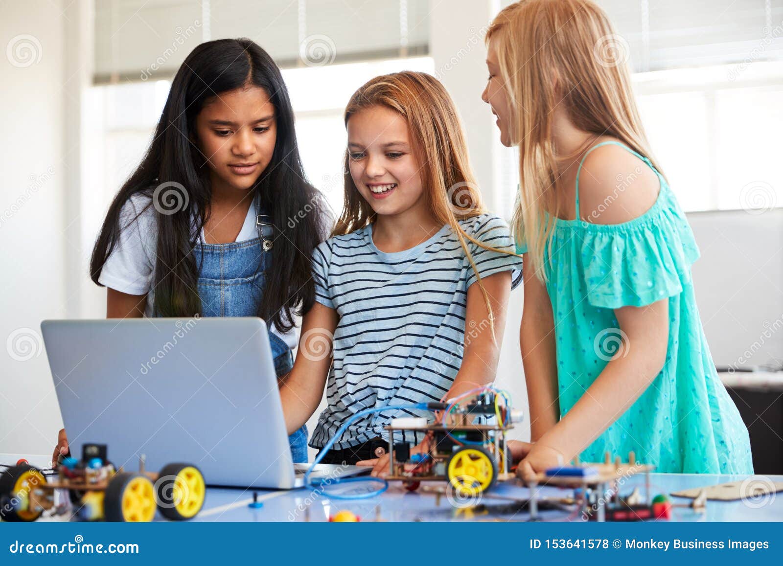 Three Female Students Building and Programing Robot Vehicle in after ...