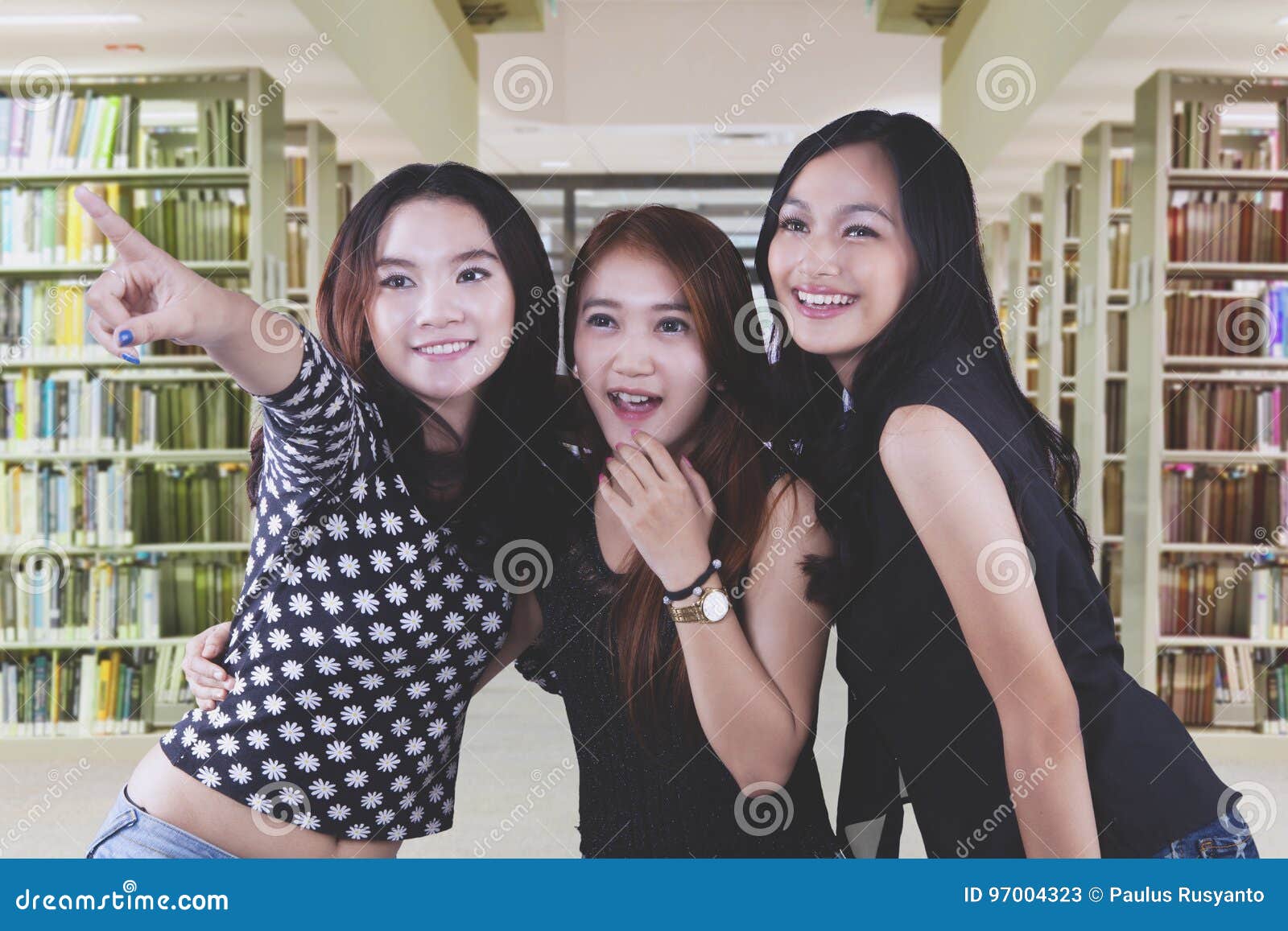 Three Female Students Looking at Something Stock Image - Image of ...