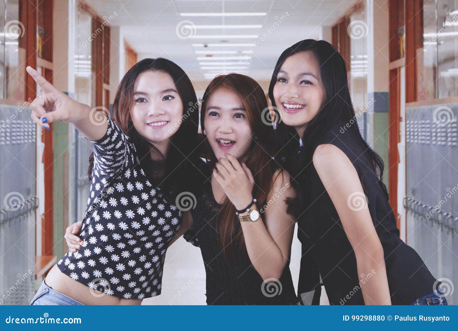 Three Female Students are Pointing at Something Stock Photo - Image of ...