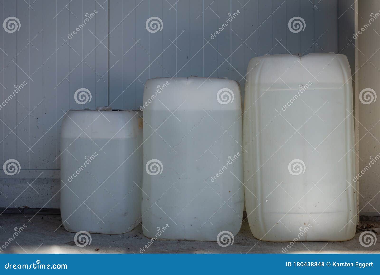 3 Filled White Canisters of Different Sizes Standing on a Wall in a ...