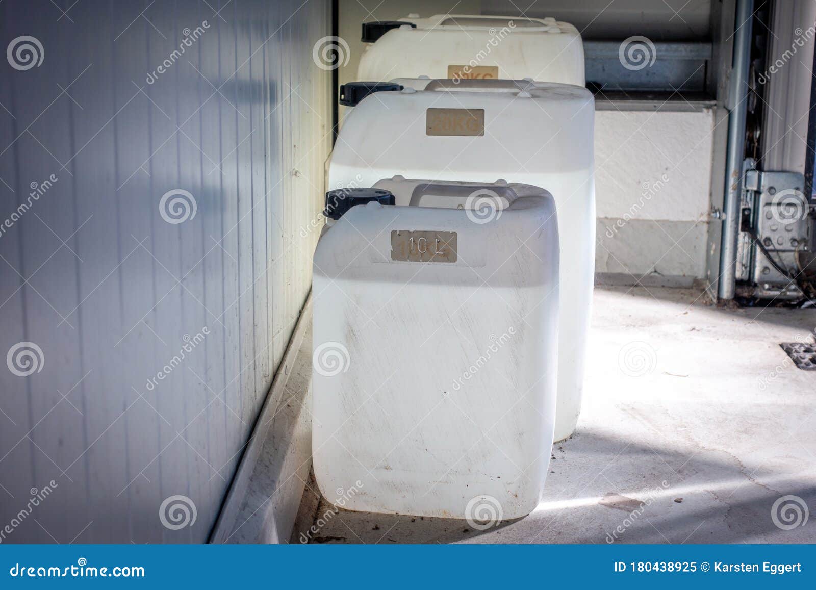 3 Filled White Canisters of Different Sizes Standing on a Wall in a ...