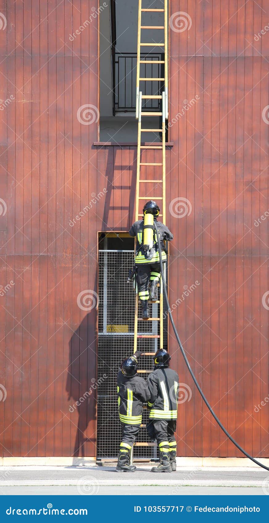 Three Firefighters in the Fire Brigade with a Long Staircase Editorial ...