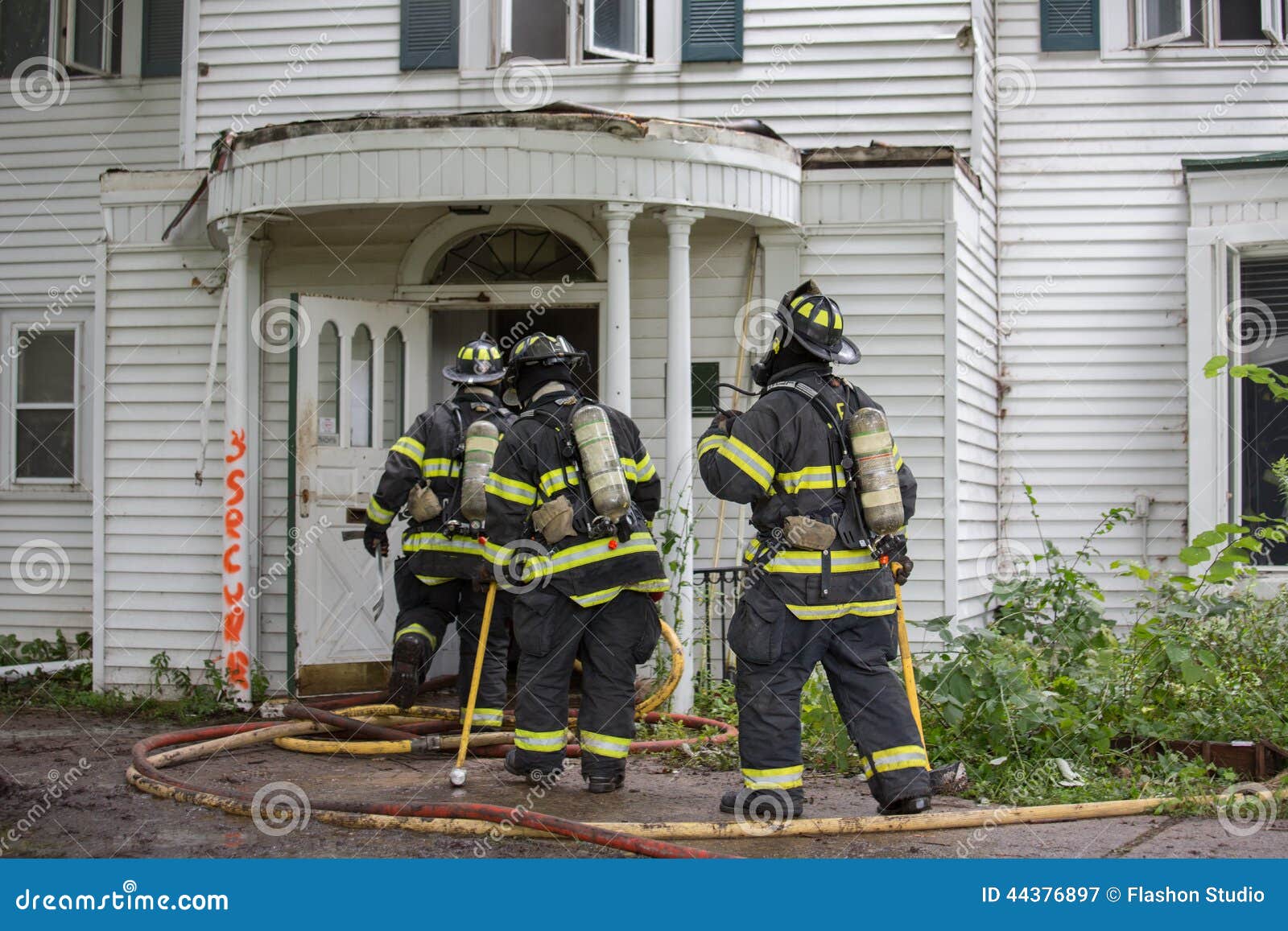 Three Firefighters On Fire Scene Walking Into A Building Royalty-Free ...
