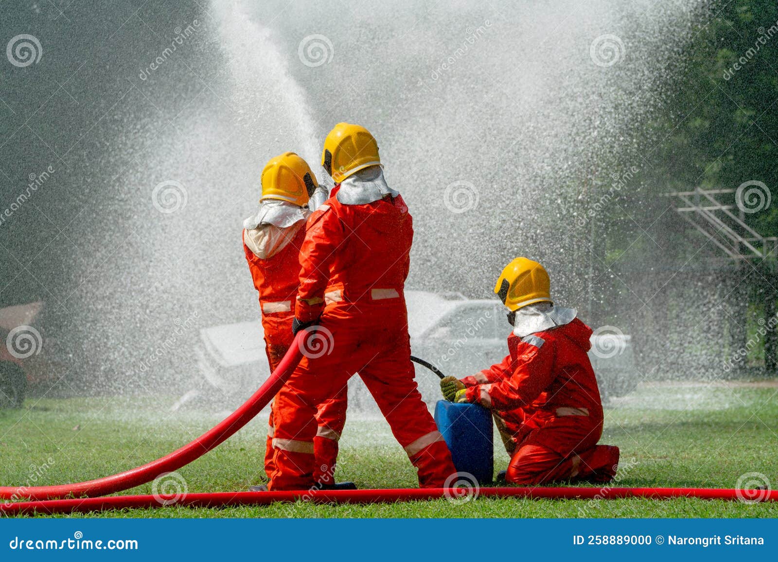 Three Firefighters Help and Support To Use Fire Sprinkler To Spray ...