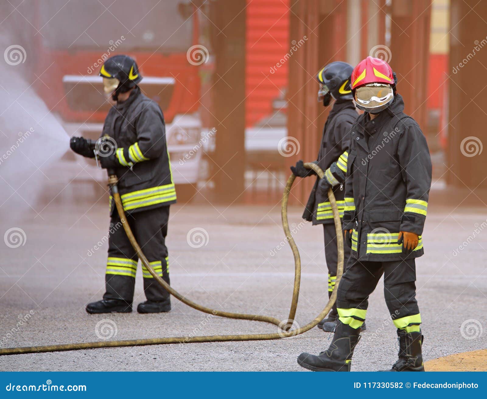 Three Firemen with the Mask Extinguish a Fire Editorial Photography ...