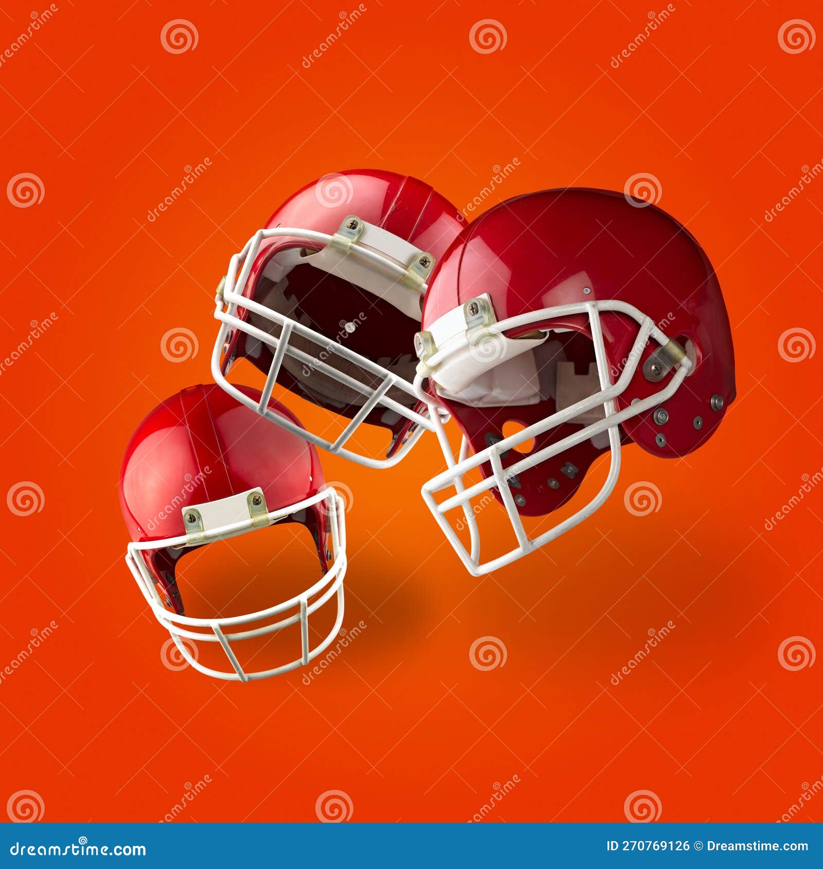 Three Floating Red American Football Helmets on Orange Gradient Stock ...
