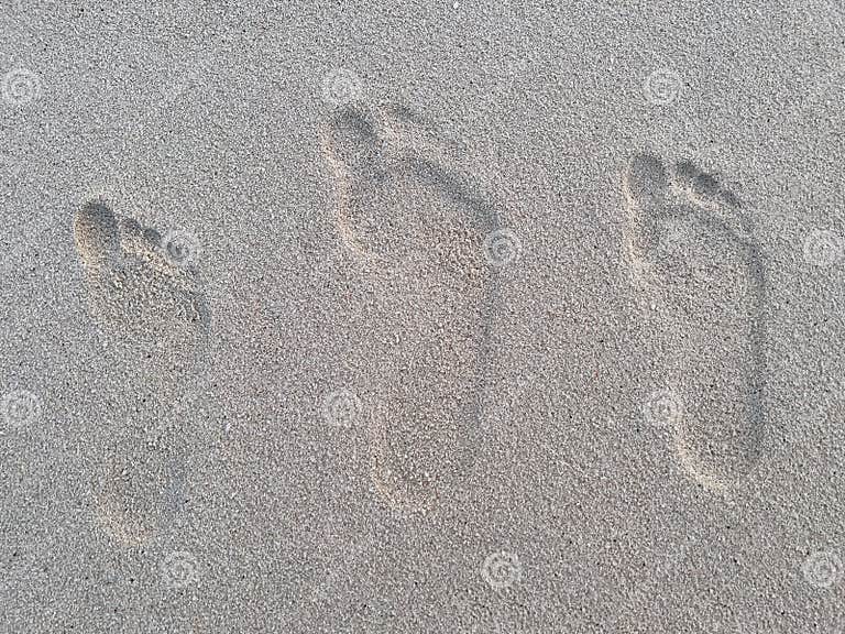 Three Footprints on the Sand Stock Image - Image of texture, barefoot ...