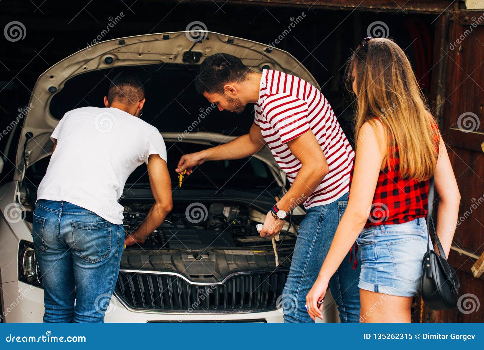 Young People Checking Motor Oil on a Car Stock Image - Image of ...