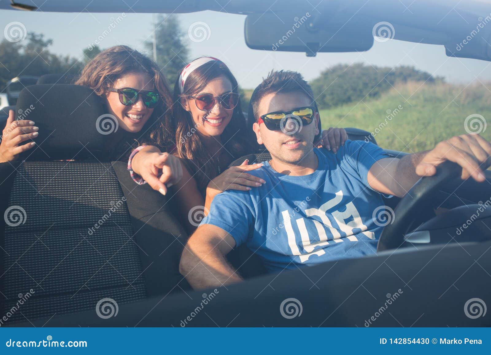 Three Friends Driving Around in a Convertible Exploring Stock Photo ...