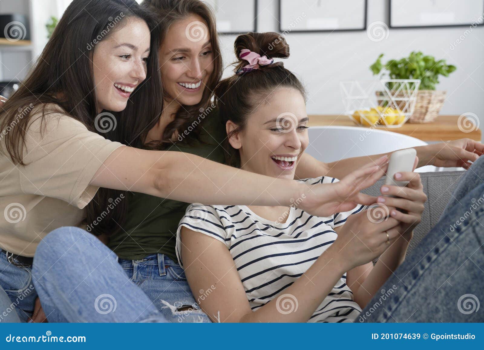 Three Best Friends Having Fun while Browsing Mobile Phone Stock Image ...