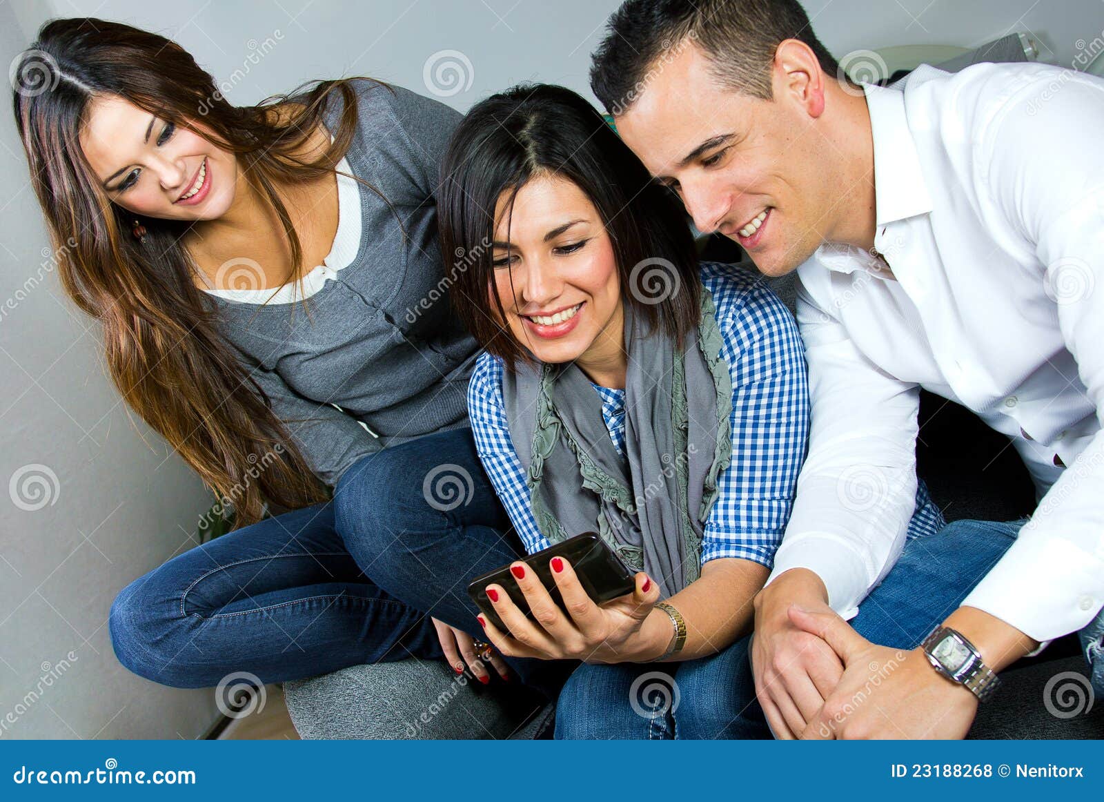 Three Friends Having Fun with a Mobile Phone Stock Photo - Image of ...