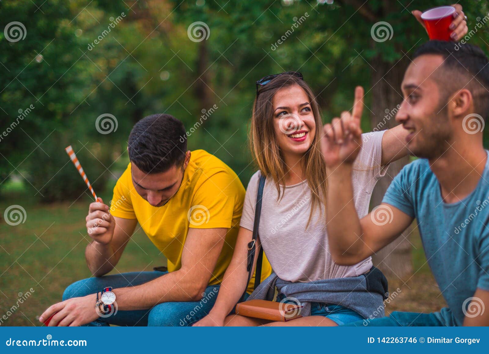 Three Friends Having Fun while Sitting in the Park Stock Photo - Image ...