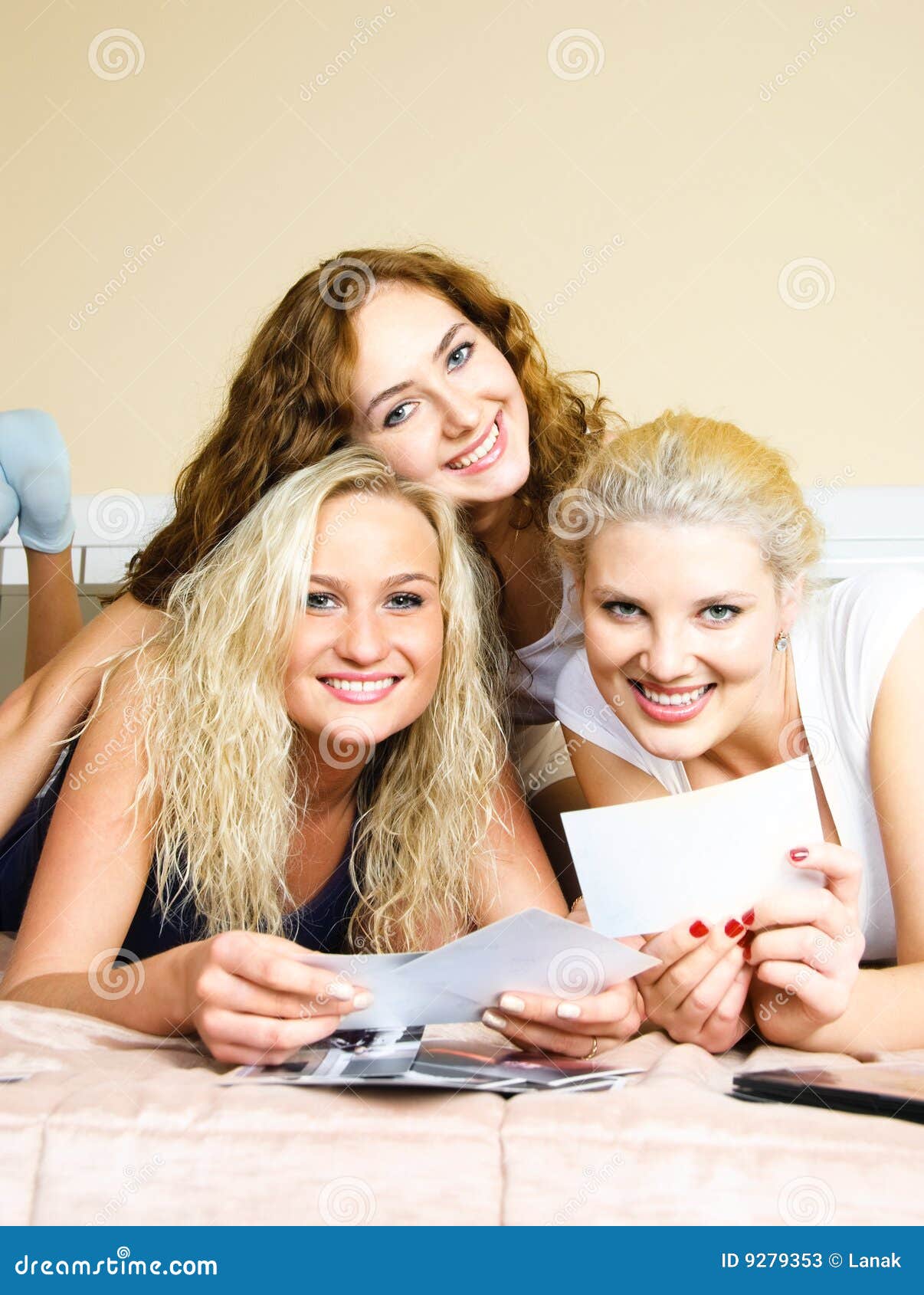 Three Friends Look through Old Photographs Stock Image - Image of album ...