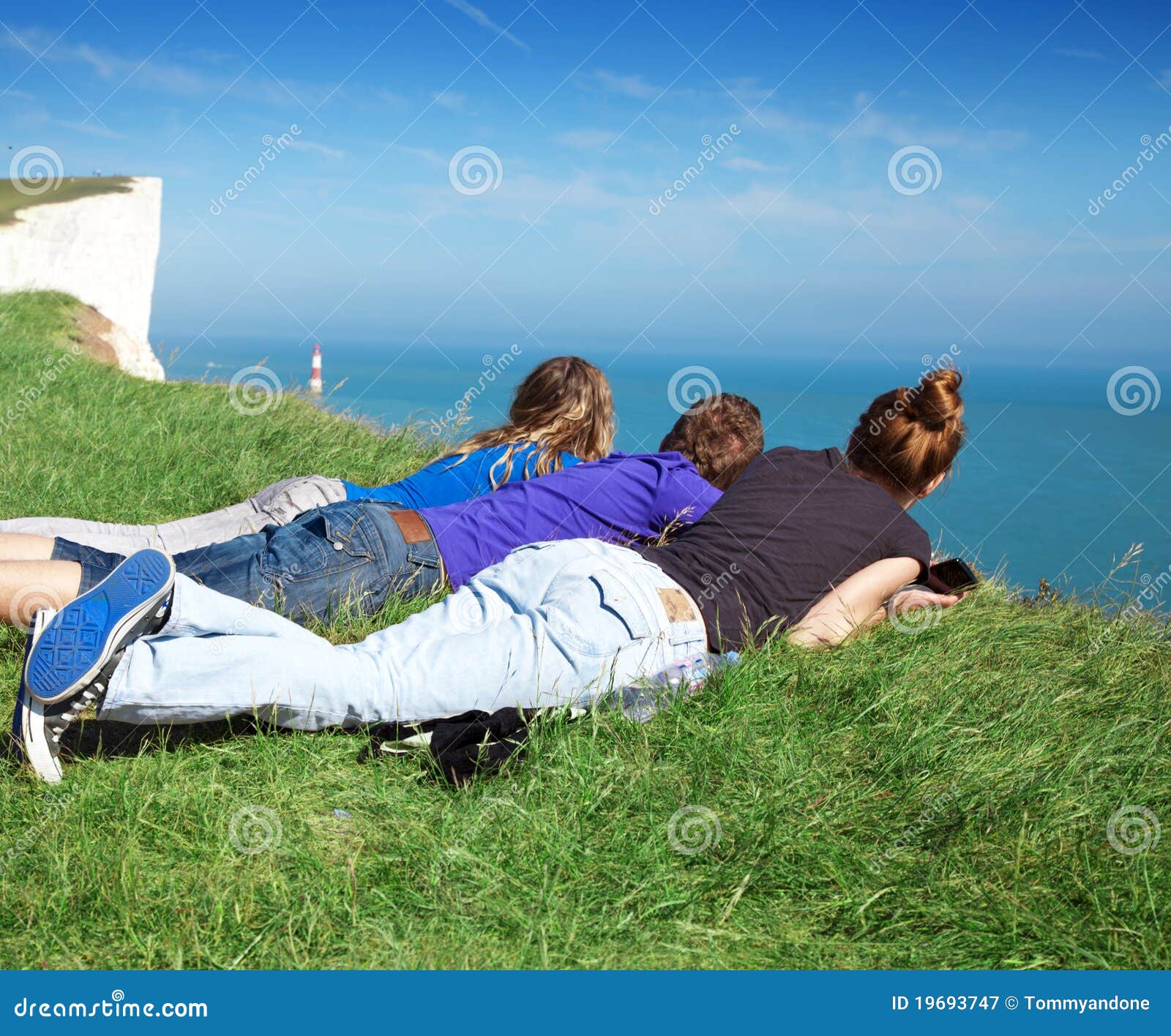 Three Friends Looking at a Lighthouse Stock Image - Image of ocean ...