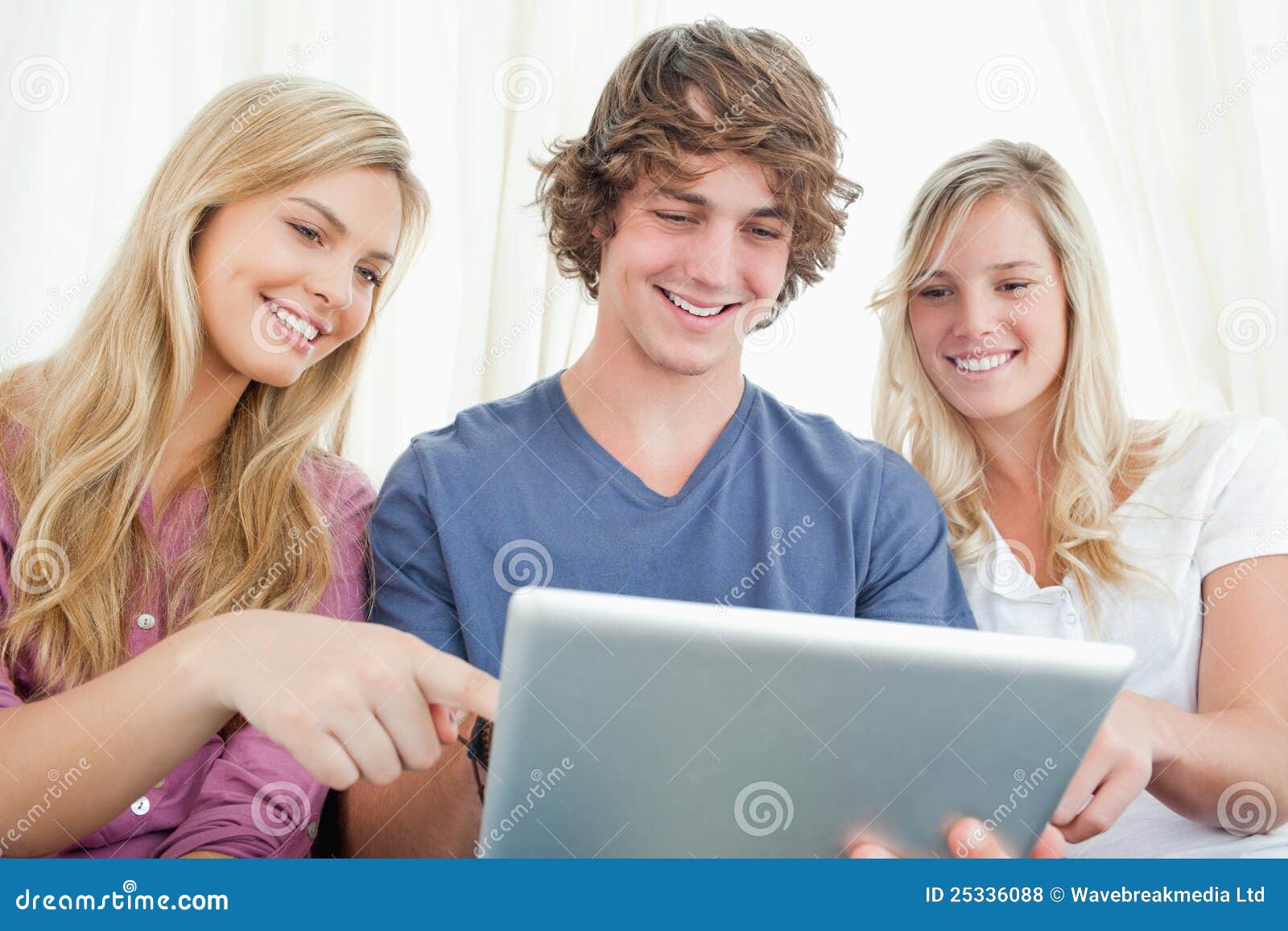 Three Friends Looking at the Screen of the Tablet Stock Photo - Image ...