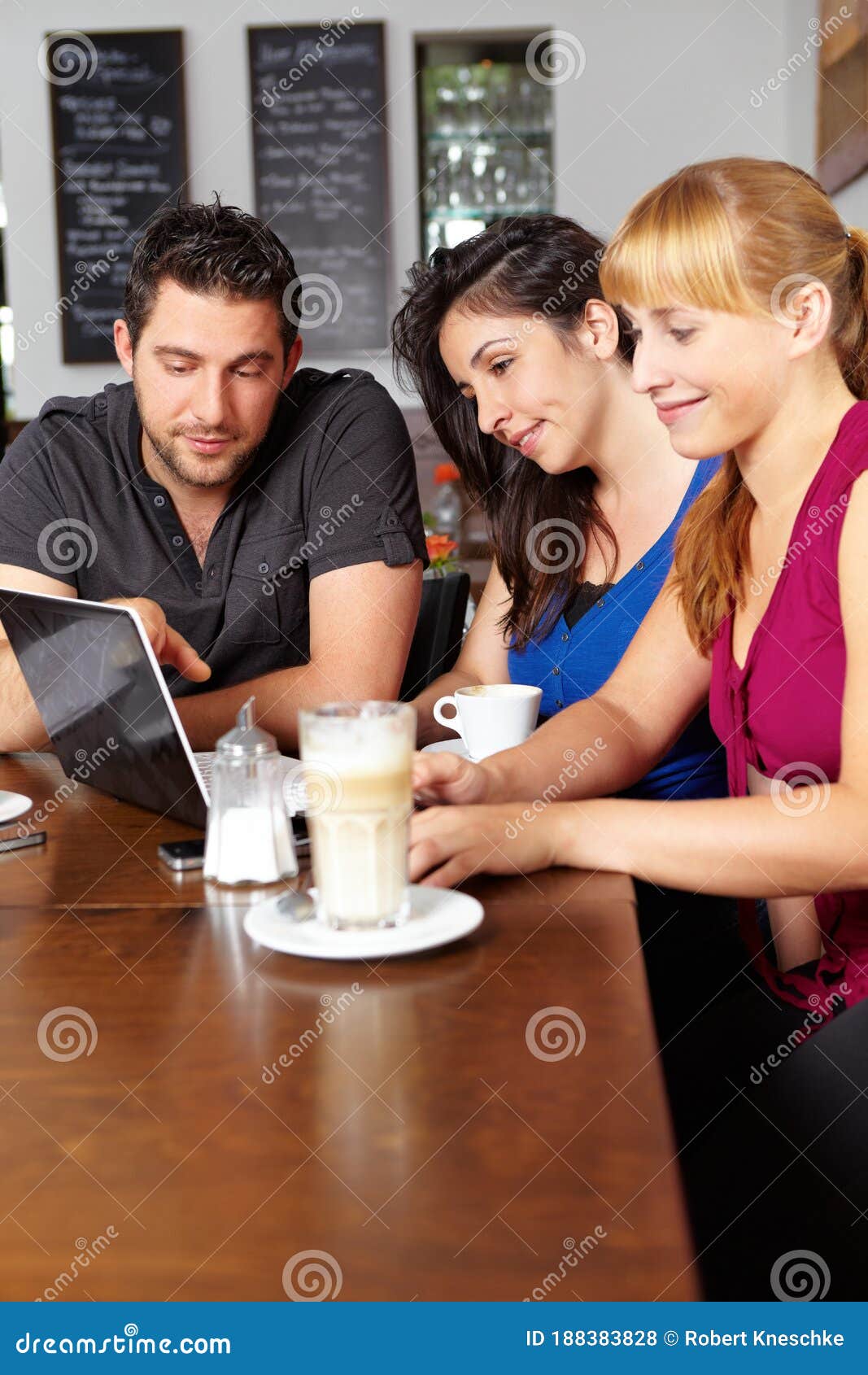 Three Friends on the Netbook in the Cafe Stock Photo - Image of cafe ...