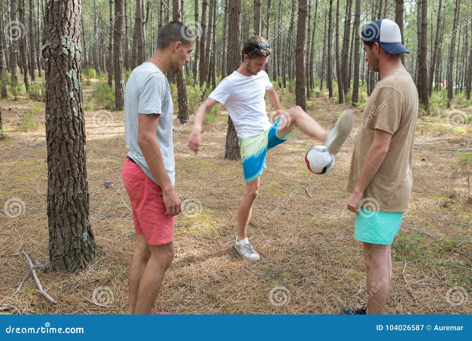 Three Friends Playing Football in Forest Stock Image - Image of summer ...