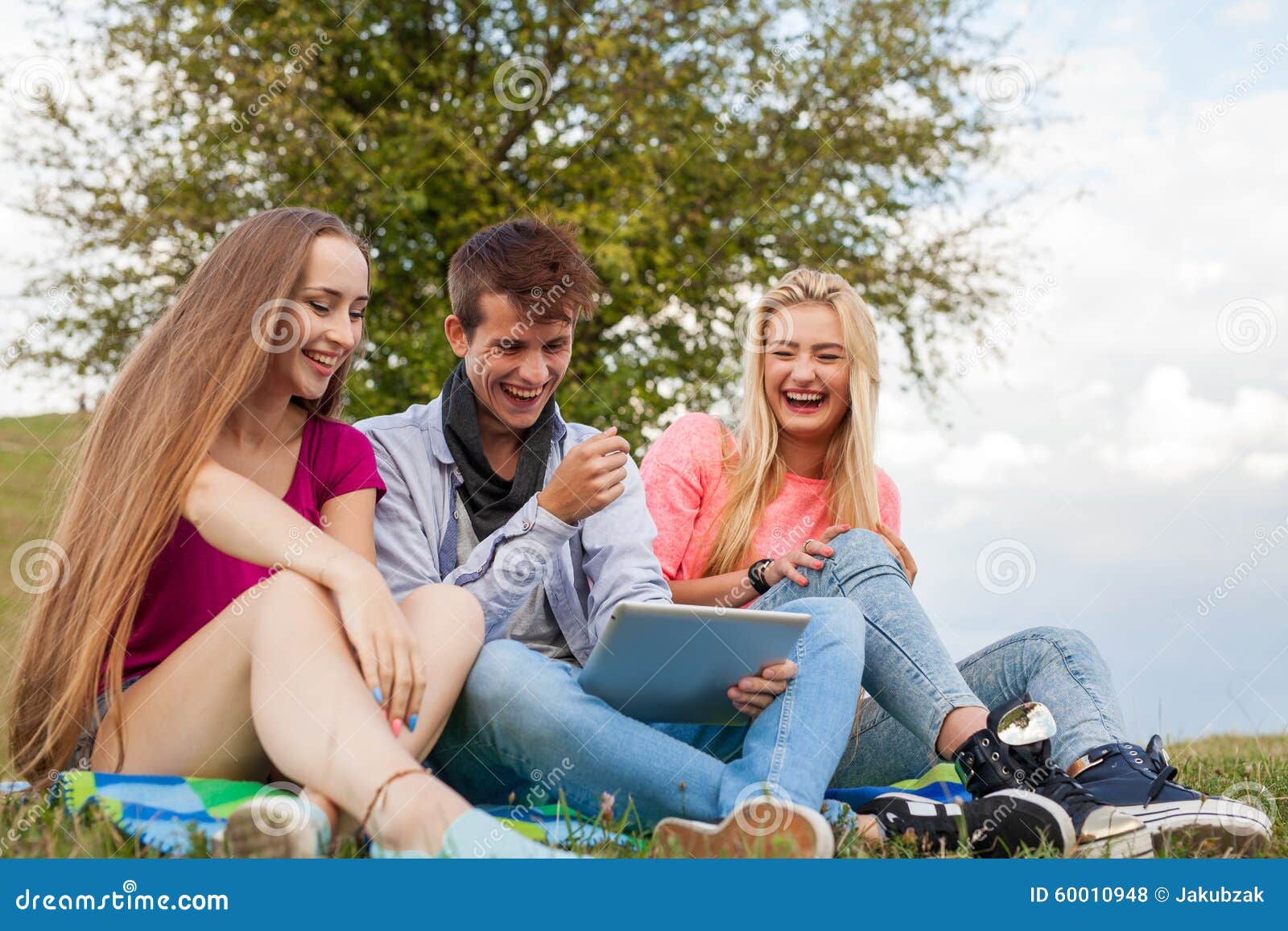 Three Friends Playing Game on Tablet Pc. they Winning Again. Stock ...