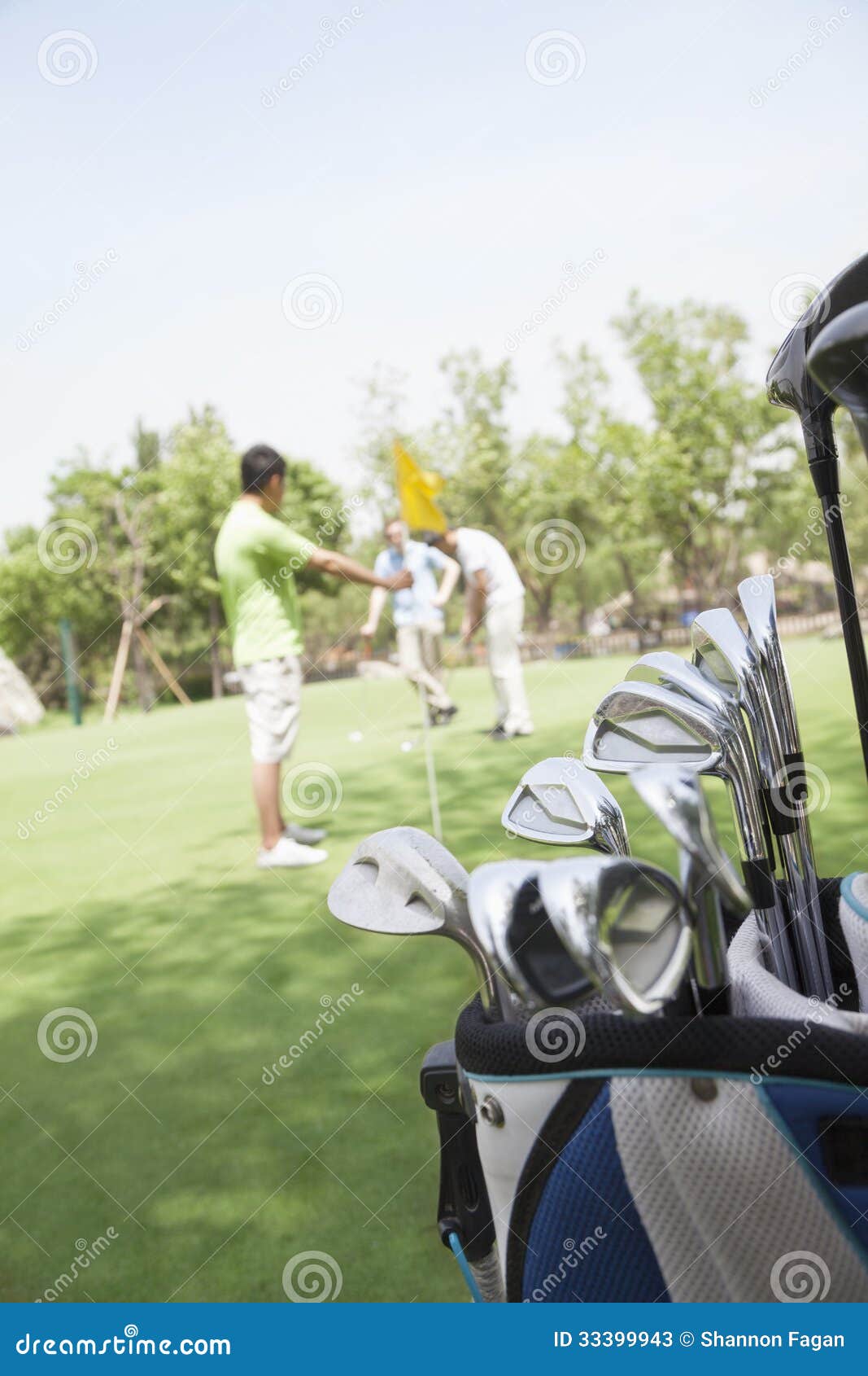 Three Friends Playing Golf on the Golf Course, Focus on the Caddy Stock ...