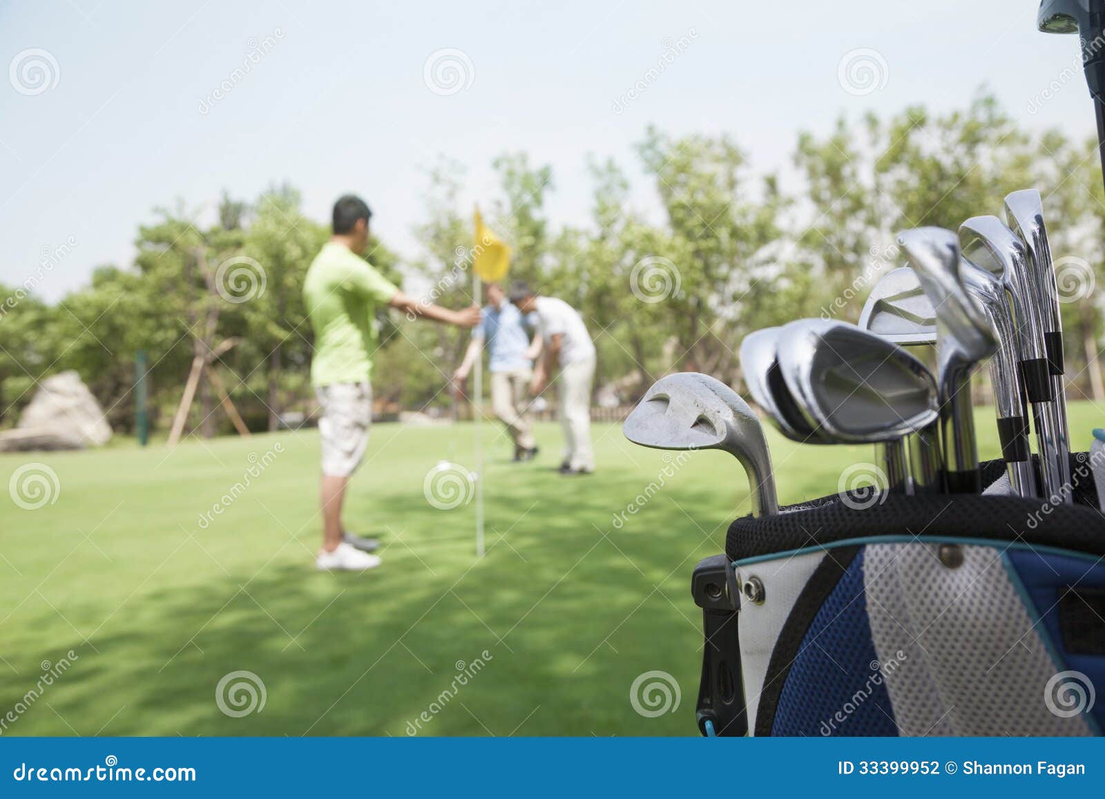 Three Friends Playing Golf on the Golf Course, Focus on the the Caddy ...
