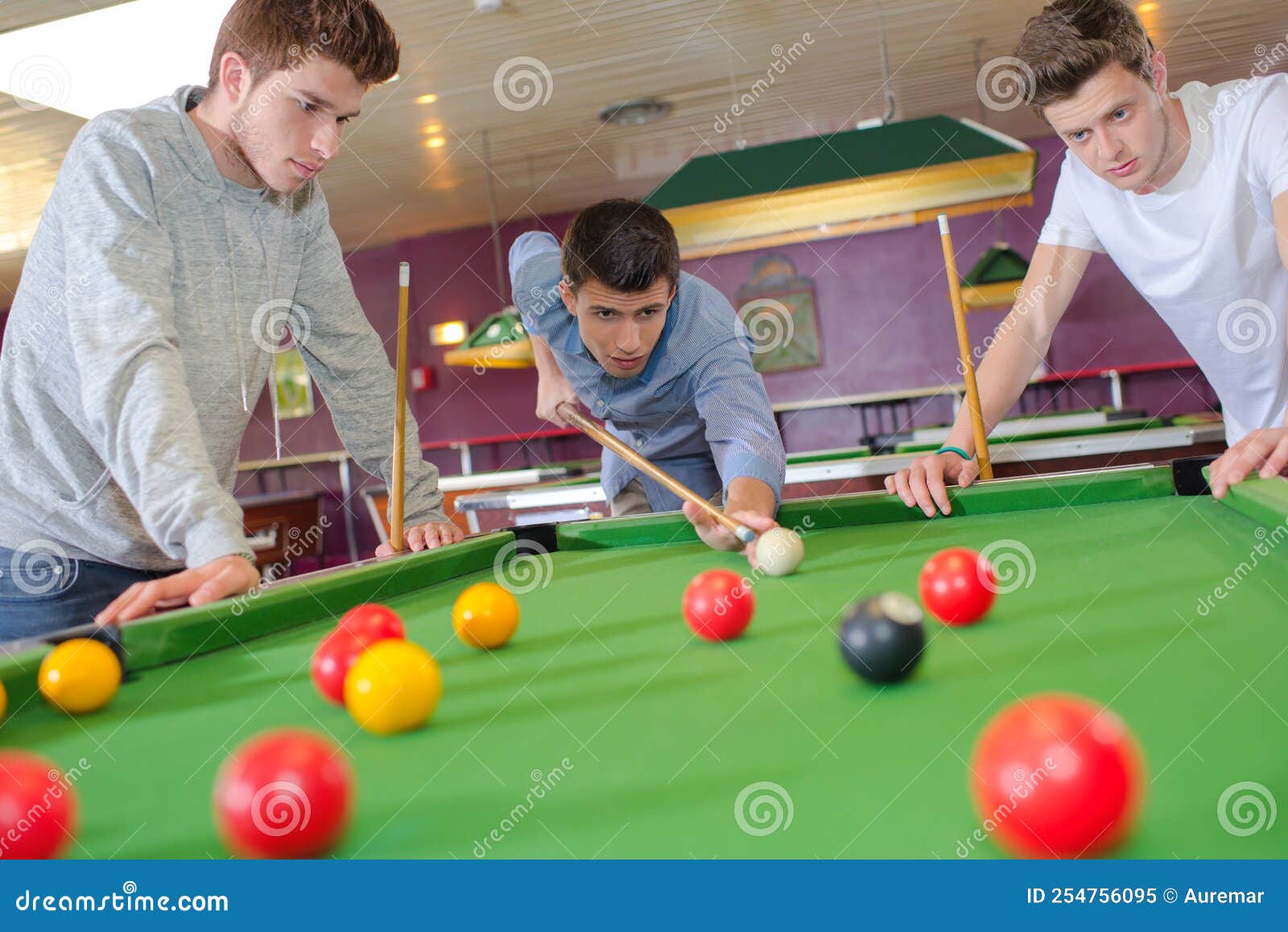 Three friends playing pool stock image. Image of caucasian - 254756095