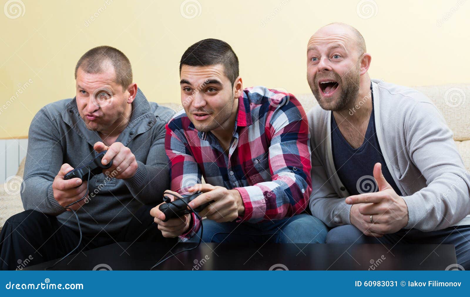 Three Friends Playing Video Games Stock Image - Image of bachelors ...