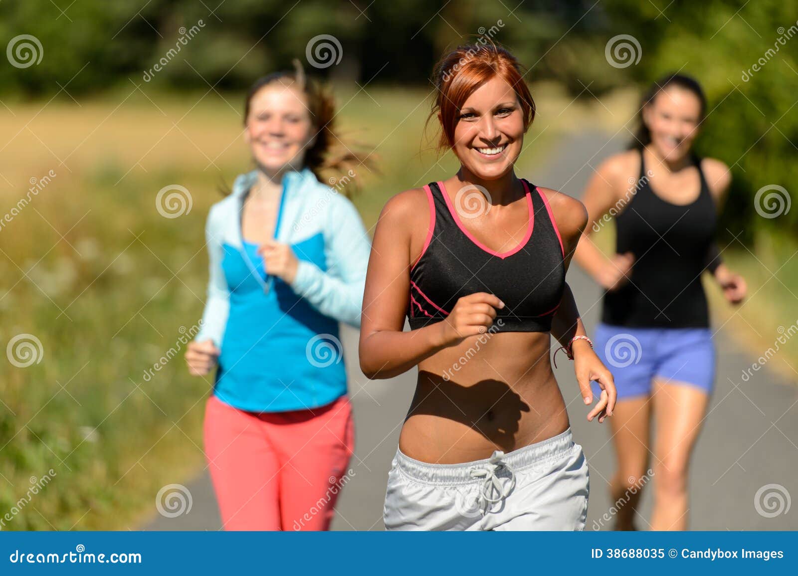Three Friends Running Outdoors Smiling Stock Image - Image of ...